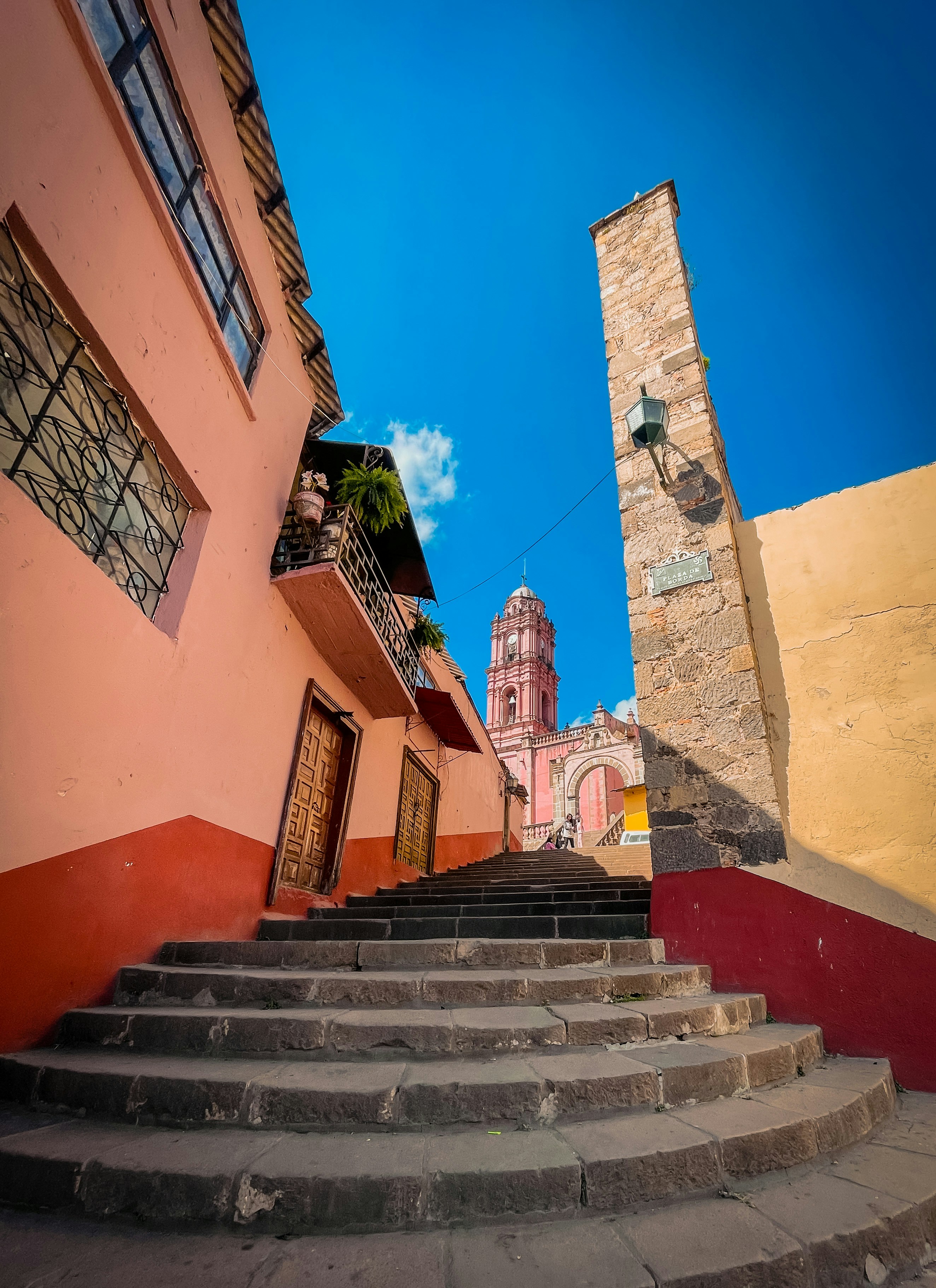 A building with a clock tower next to a set of stairs photo – Free ...