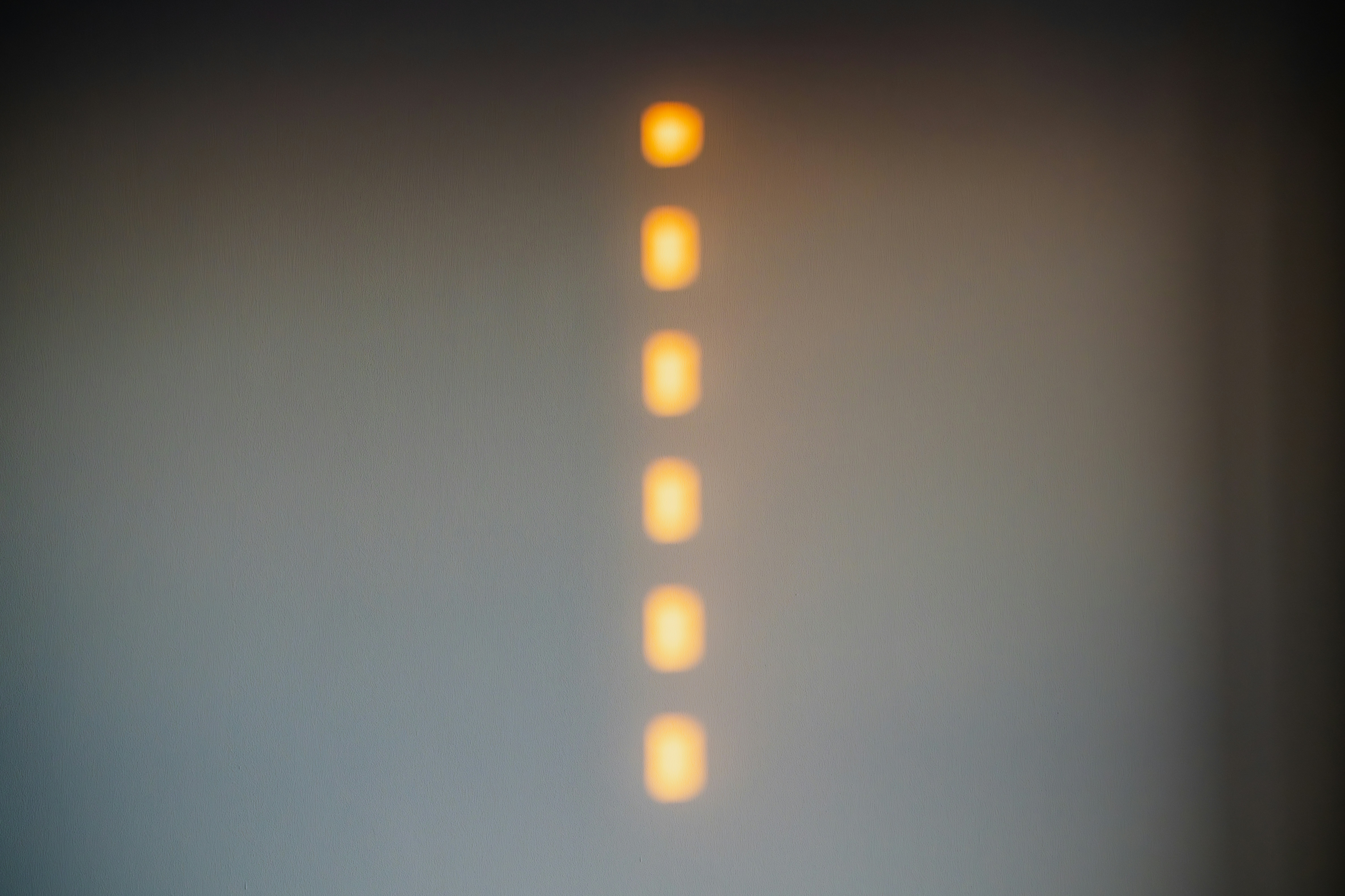 Soft Neon Dots: A Vertical Trace of Light on an Abstract Background