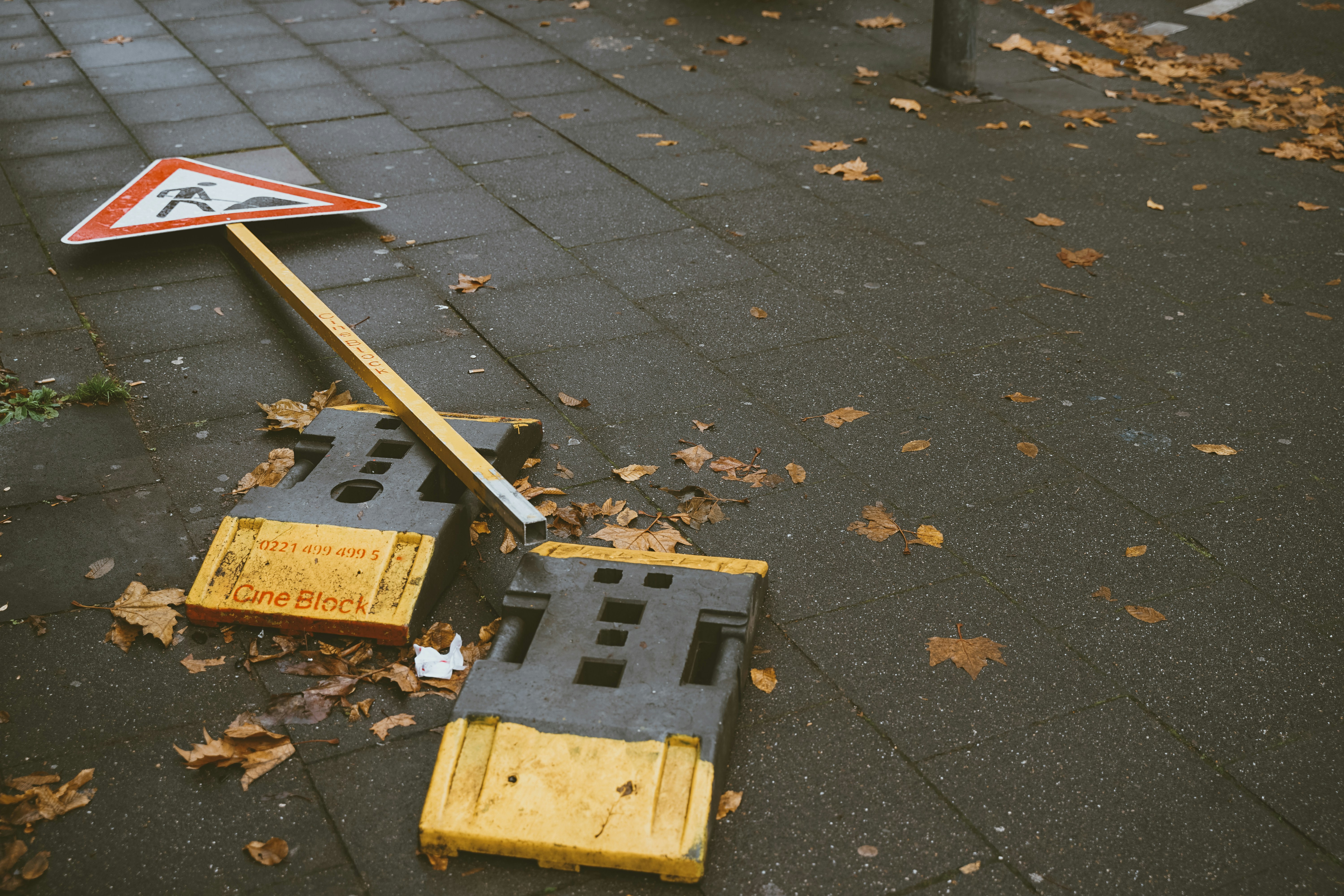 A broken street sign laying on the ground photo – Free Germany Image on ...