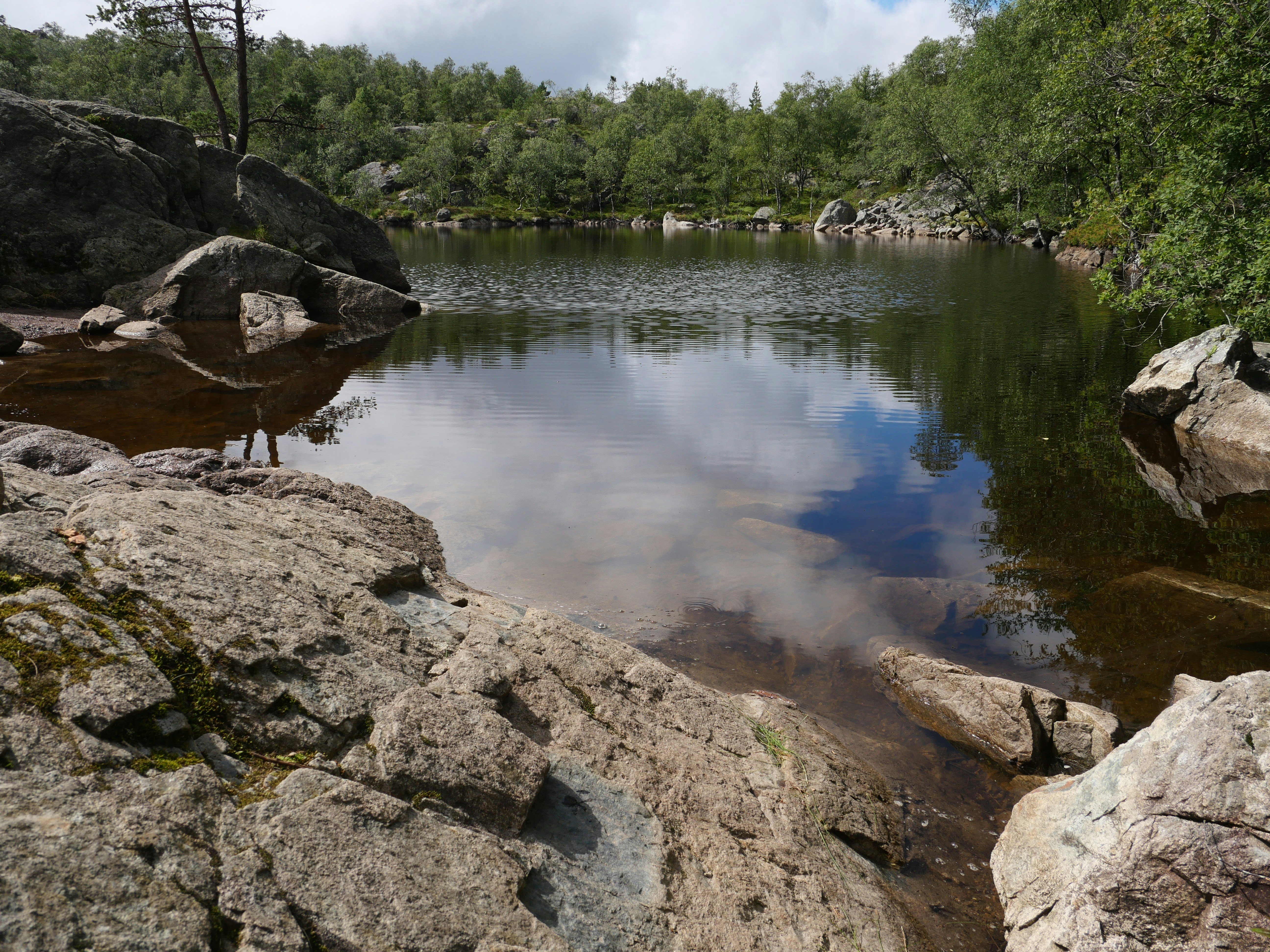 Echoes on the Granite Shore: A Quiet Lake Reflects Sky and Pines