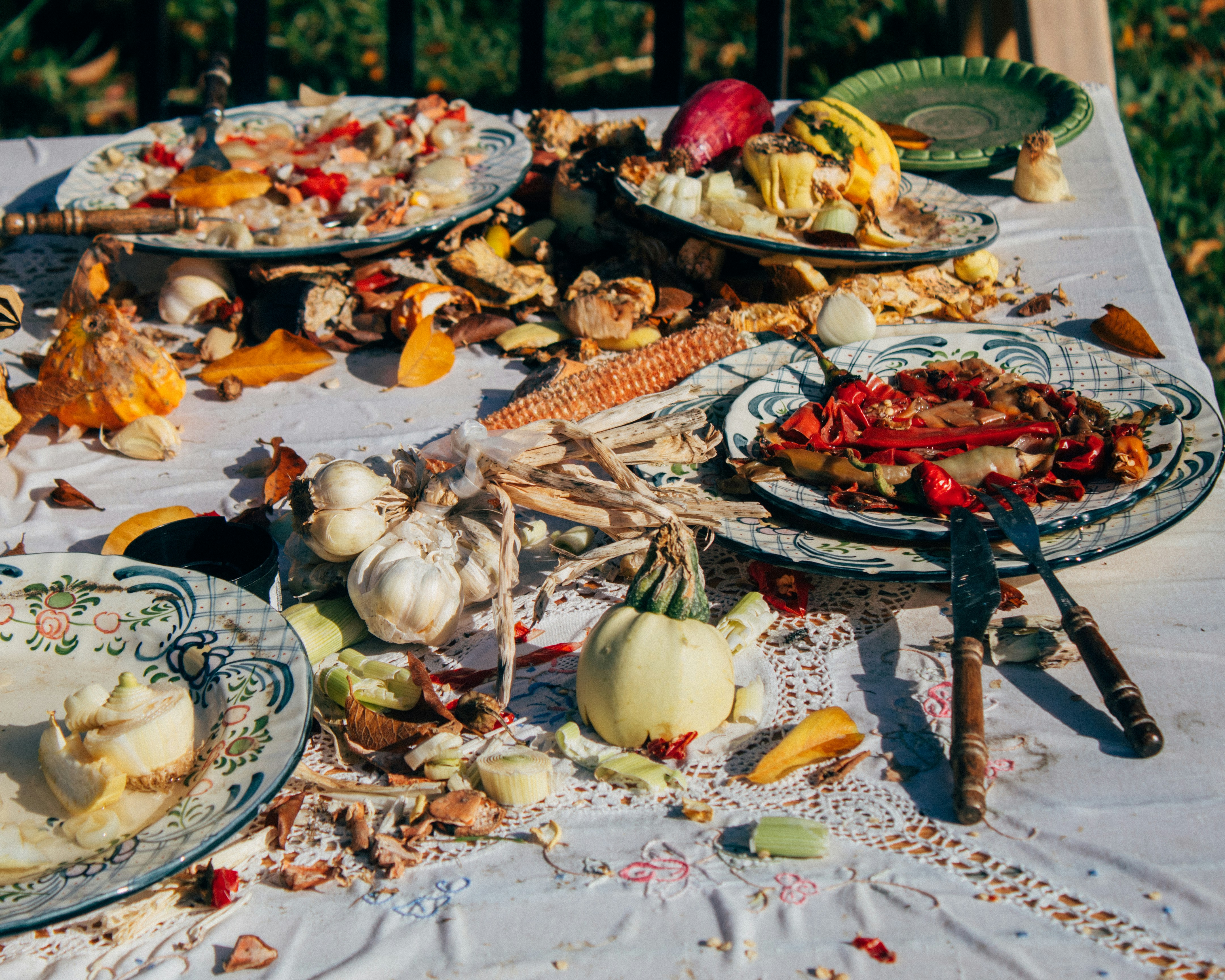 Harvest Table Reverie: Pumpkins, Garlic, and Plates in Autumn Light
