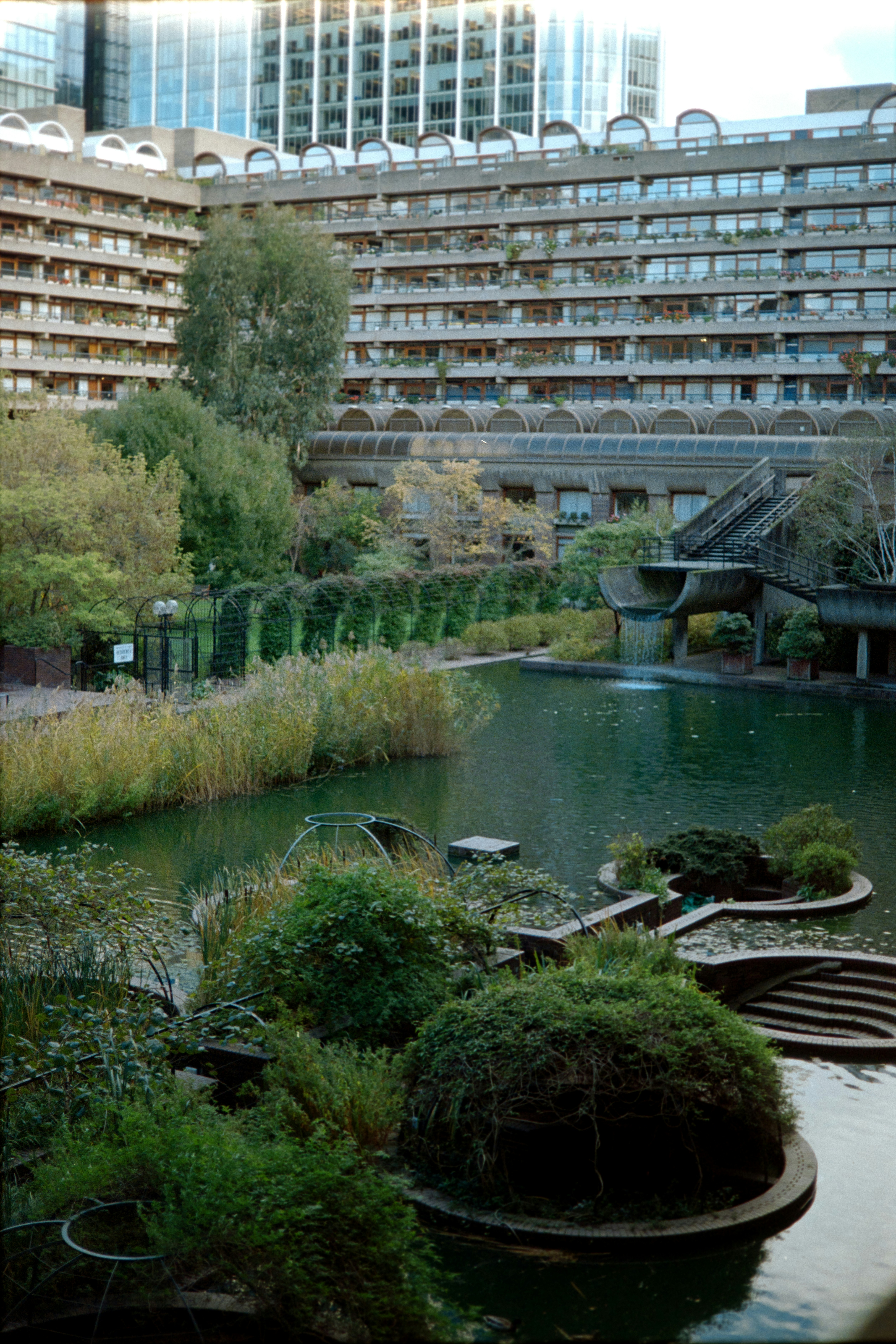 A pond in front of a large building photo – Free Barbican centre Image ...