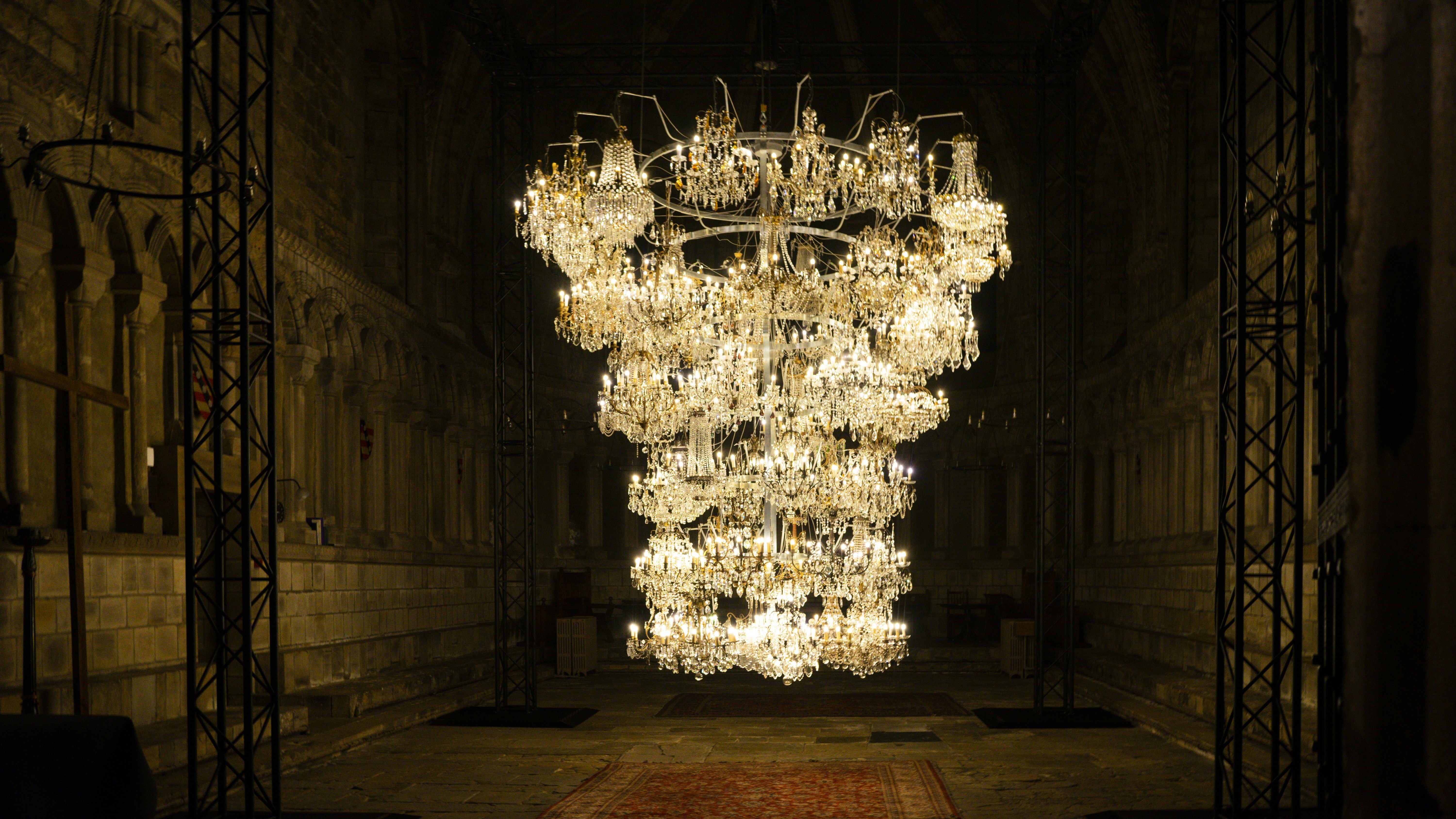 Crystal Chandelier Constellation Hanging in a Shadowed Hall