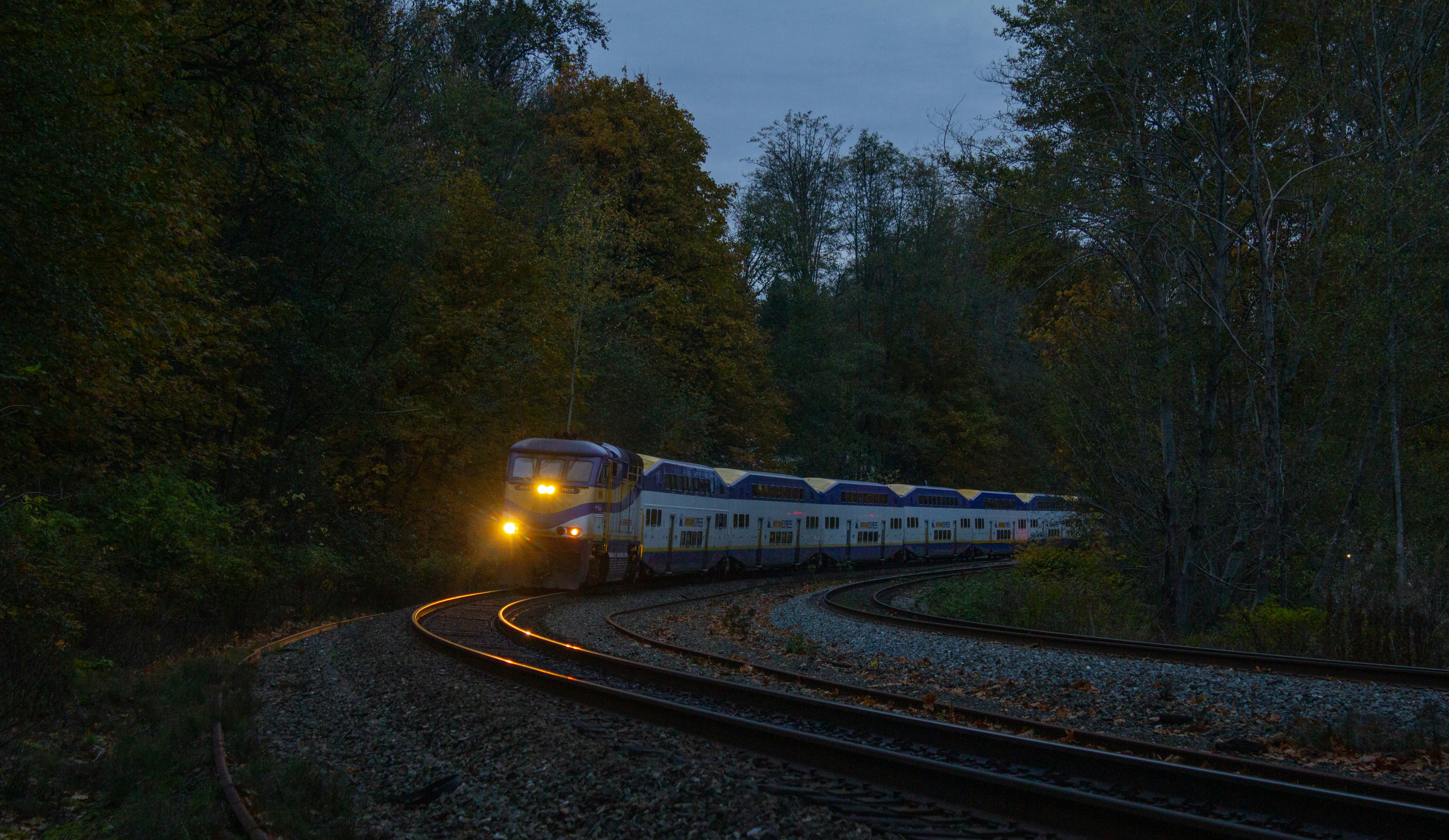 Emerging Night Express: A Faint Glow on Curved Rail