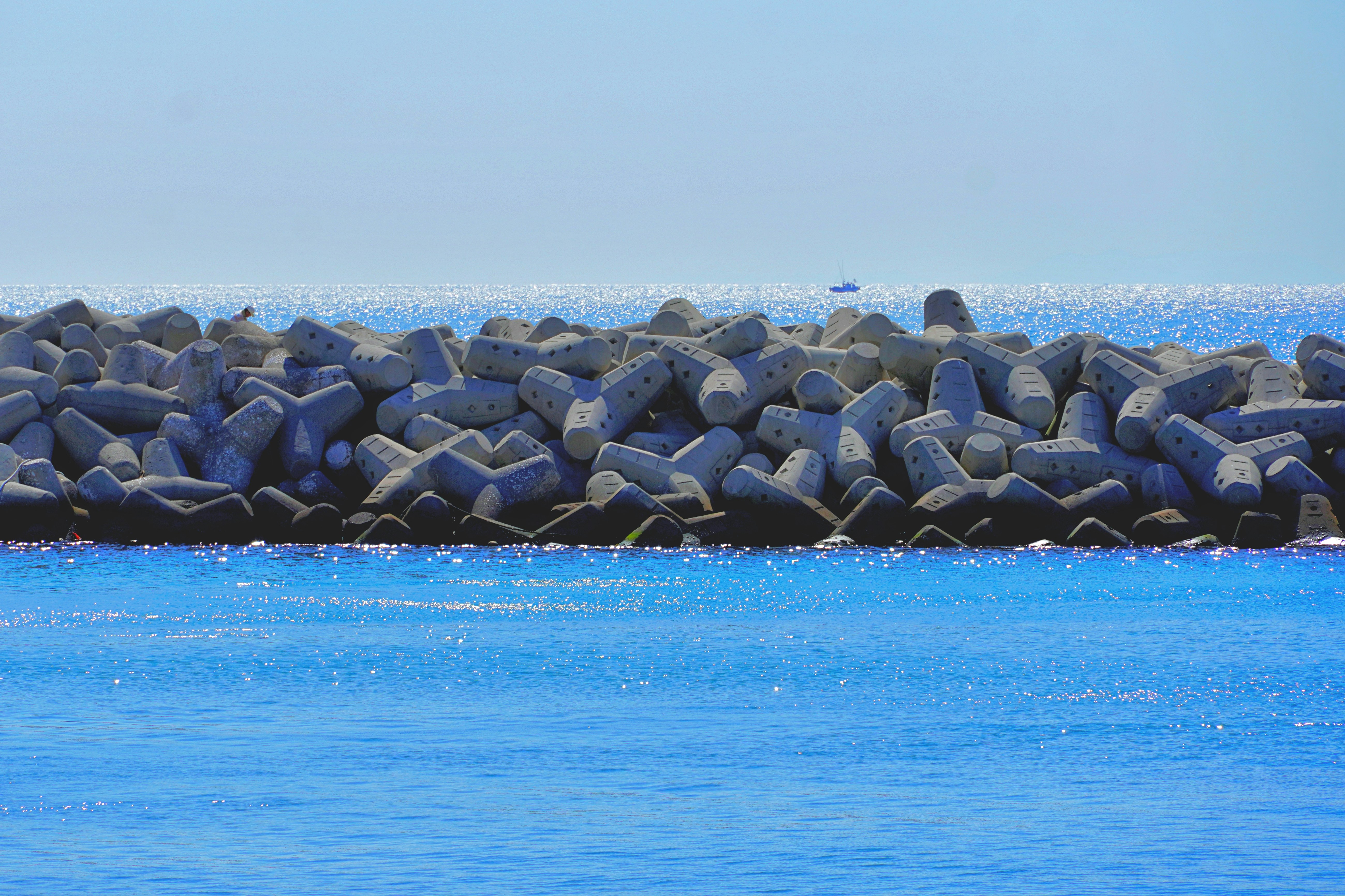 Azure Armor: Sunlit Tetrapods Guard the Glittering Sea