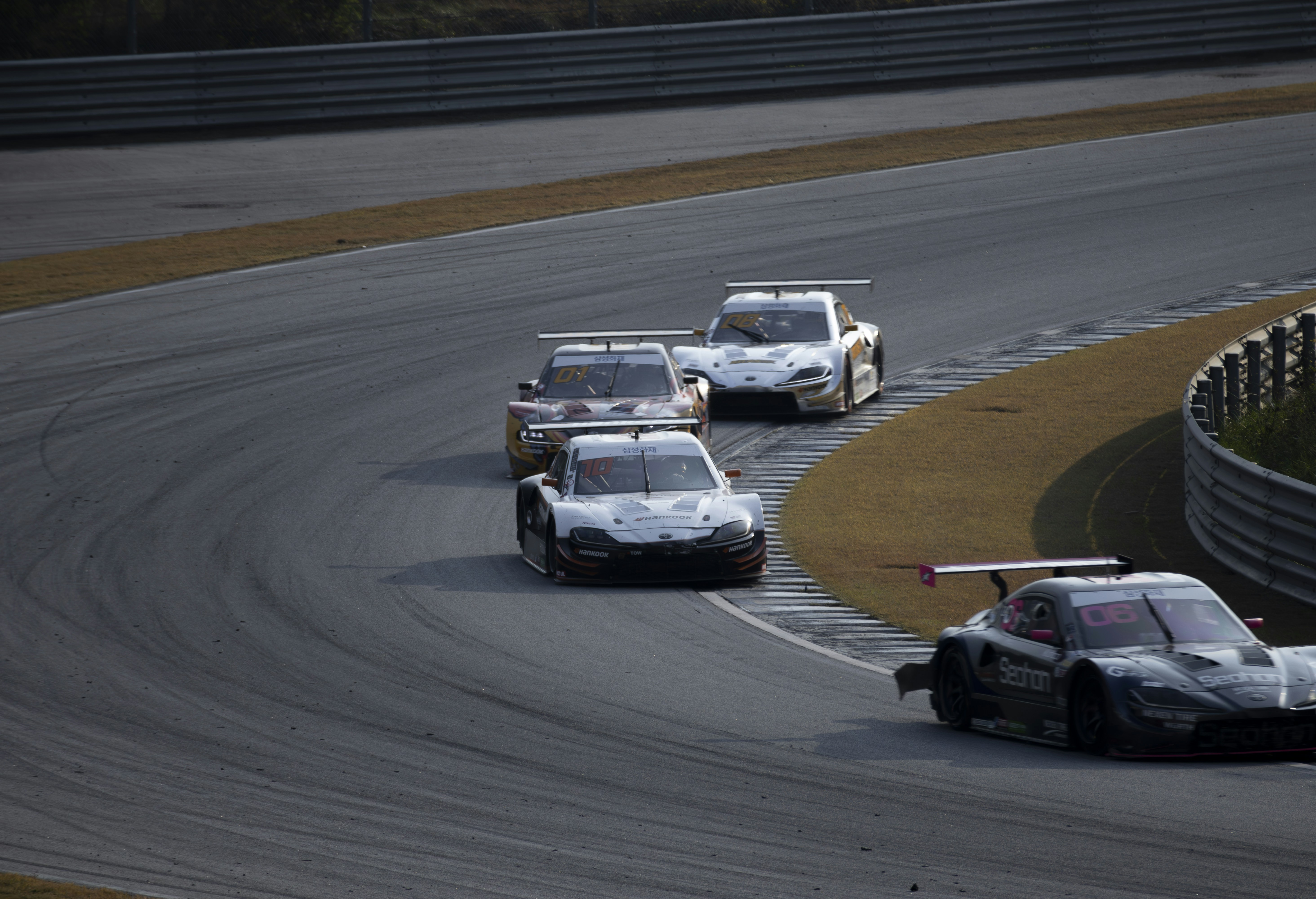 A group of race cars driving around a track photo – Free Toyota Image ...