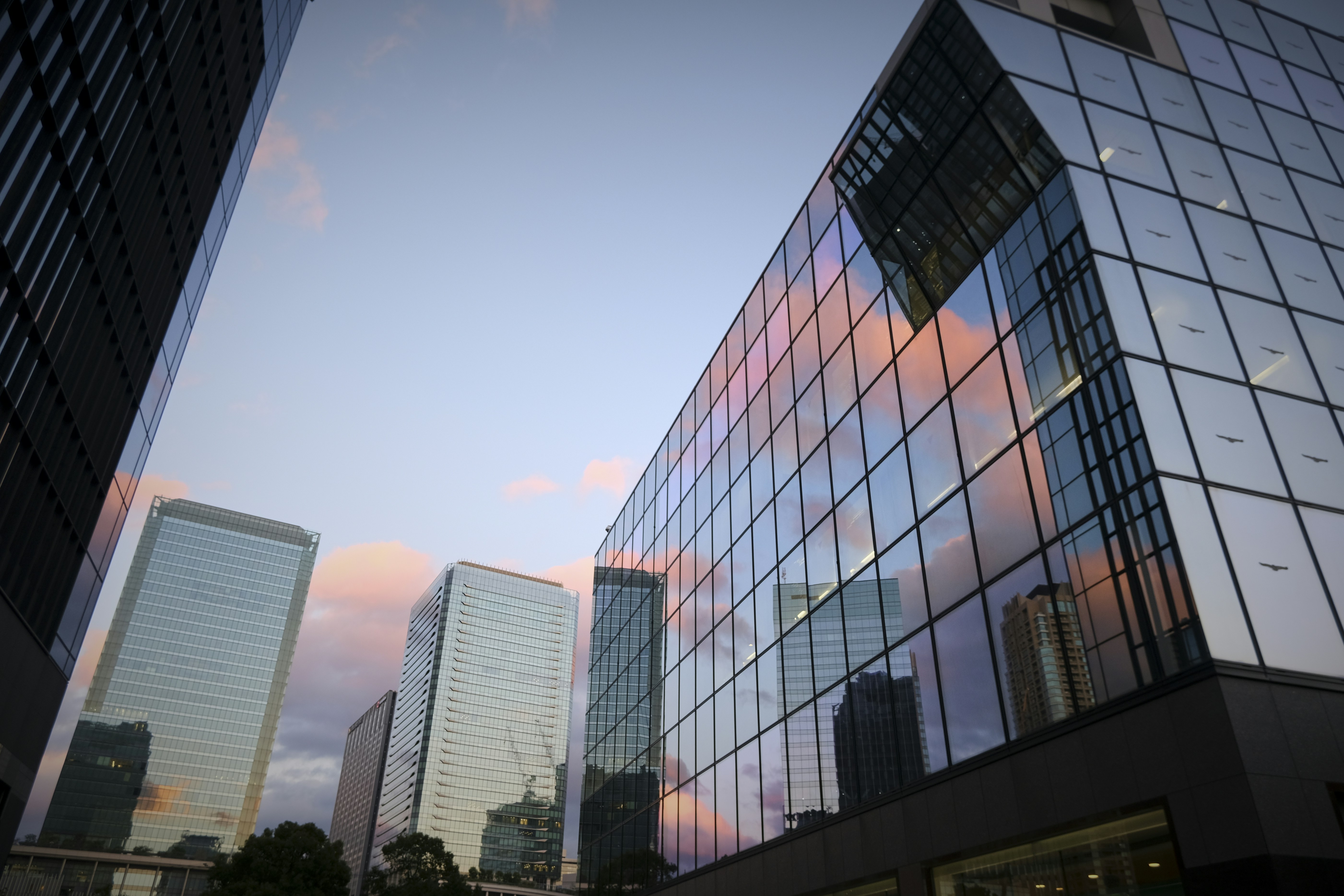 Sunset reflected in high-rise building near the famous Umeda sky building, Umeda district, Osaka, Japan