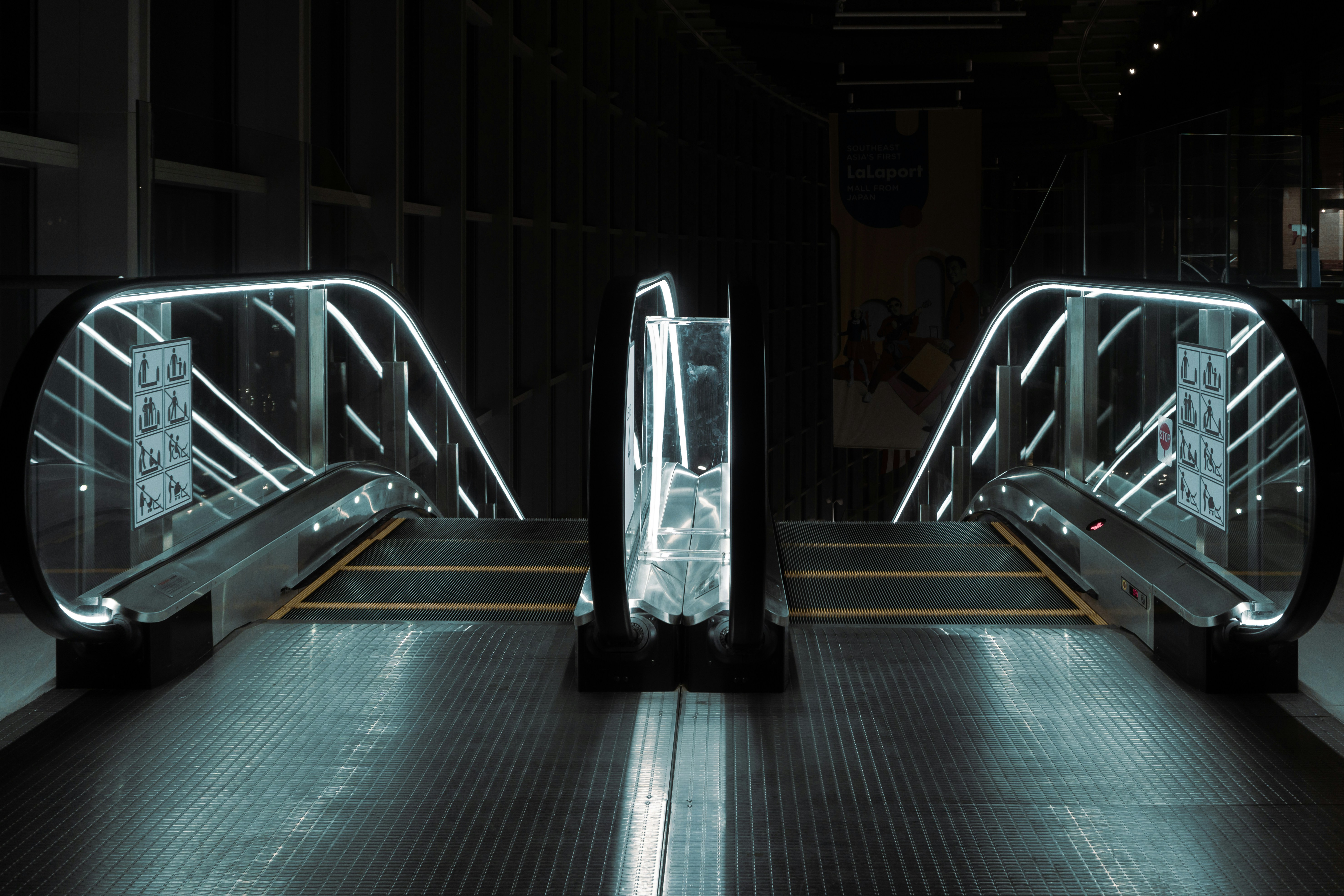 Between Glass and Glow: Neon Axis of a Silent Escalator Chamber