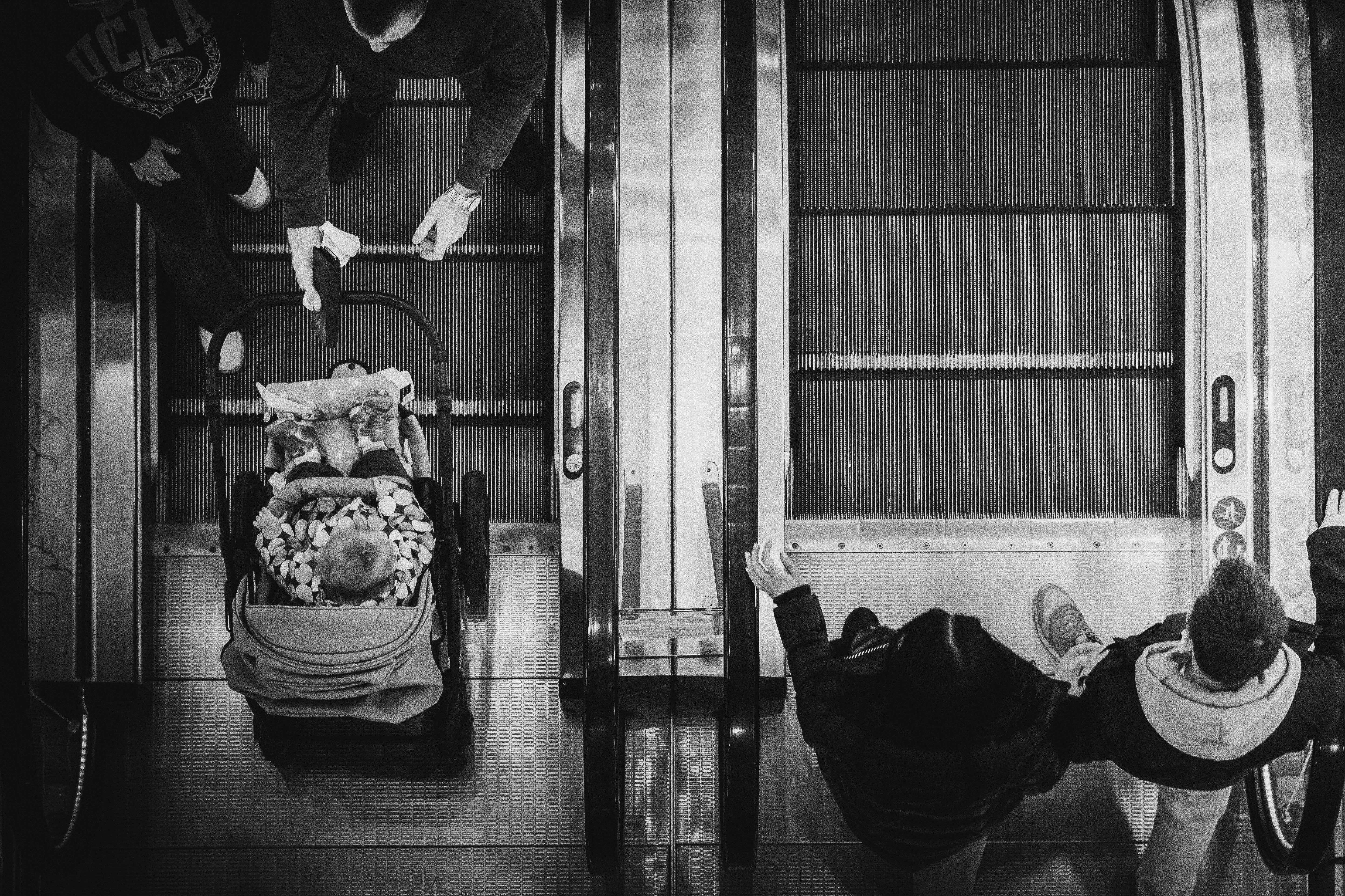 Escalator Pause: A Black-and-White Moment at the Station