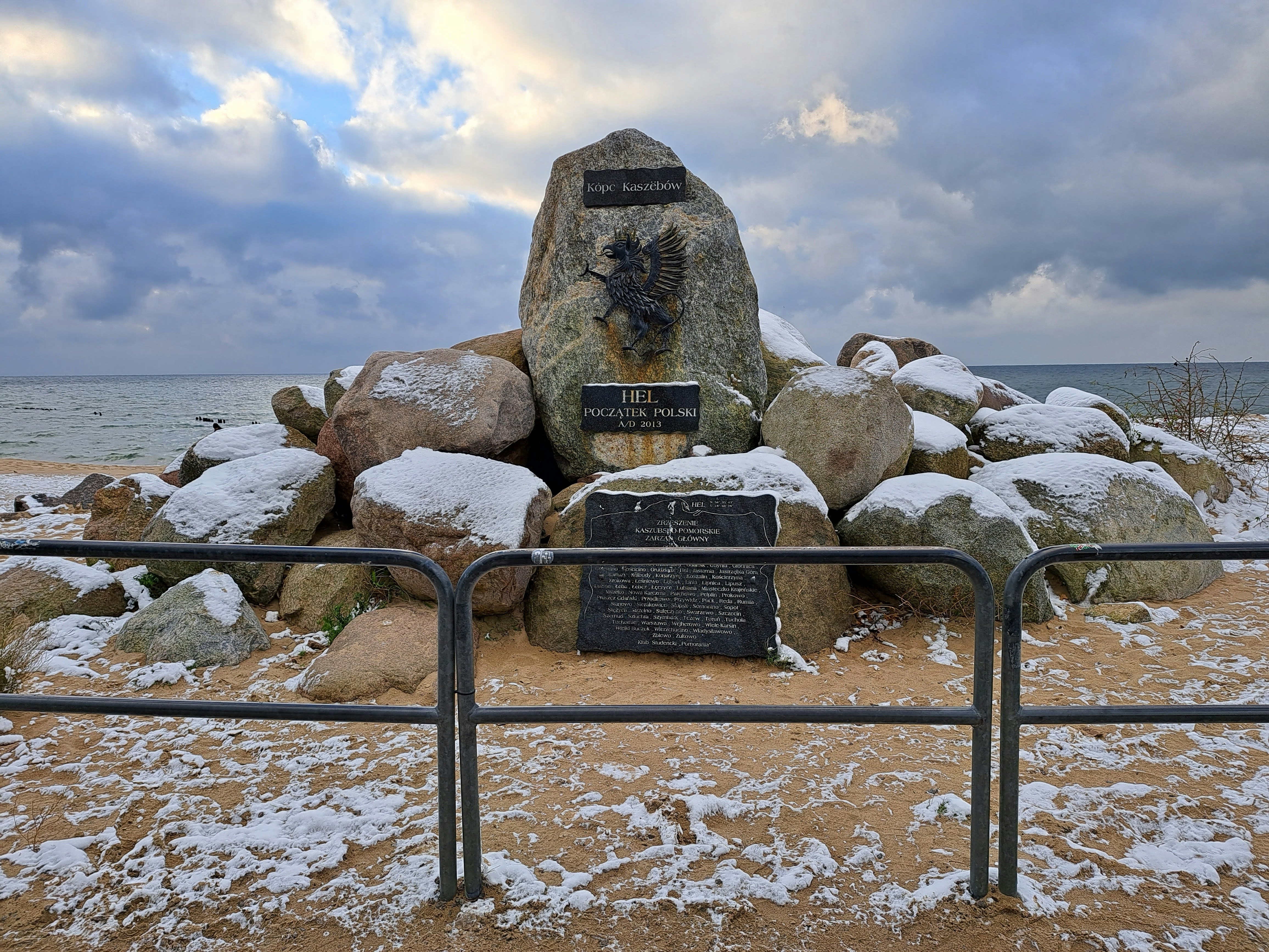 Arctic-Edge Memorial: Snow-Kissed Stone Guarding the Quiet Sea