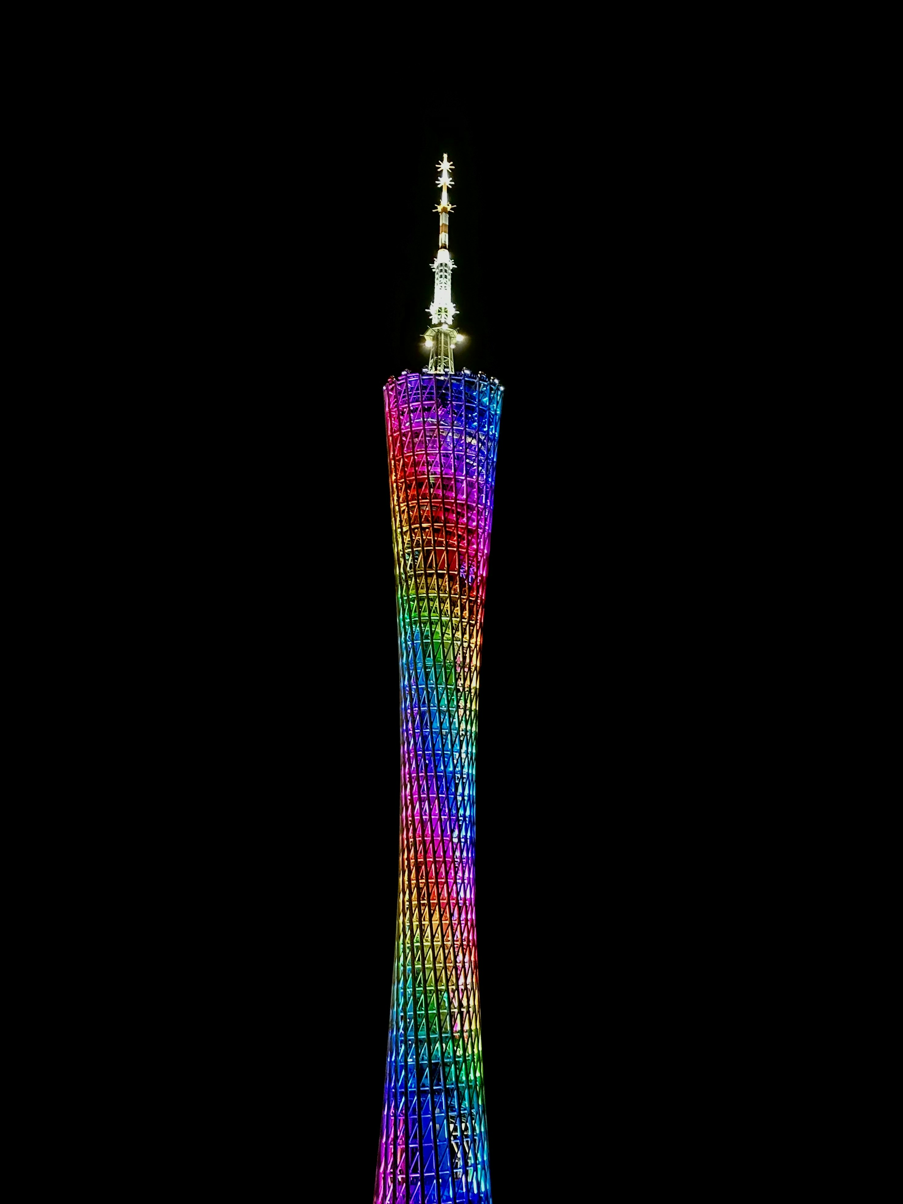Prismatic Spiral: Night Rainbow Light Drapes a Tower