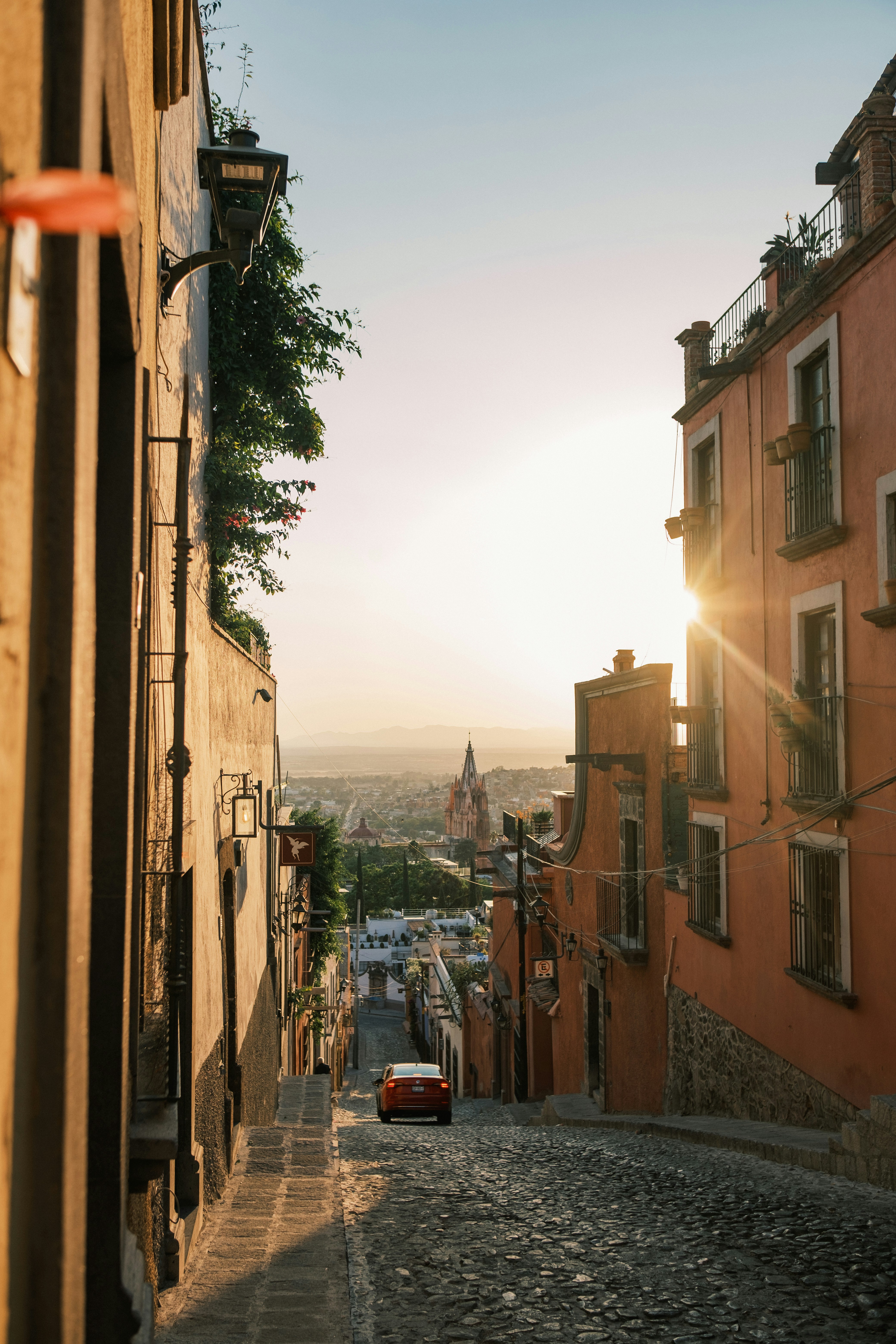 Sunlit Slope: A Cobblestone Street Toward the Distant Spire