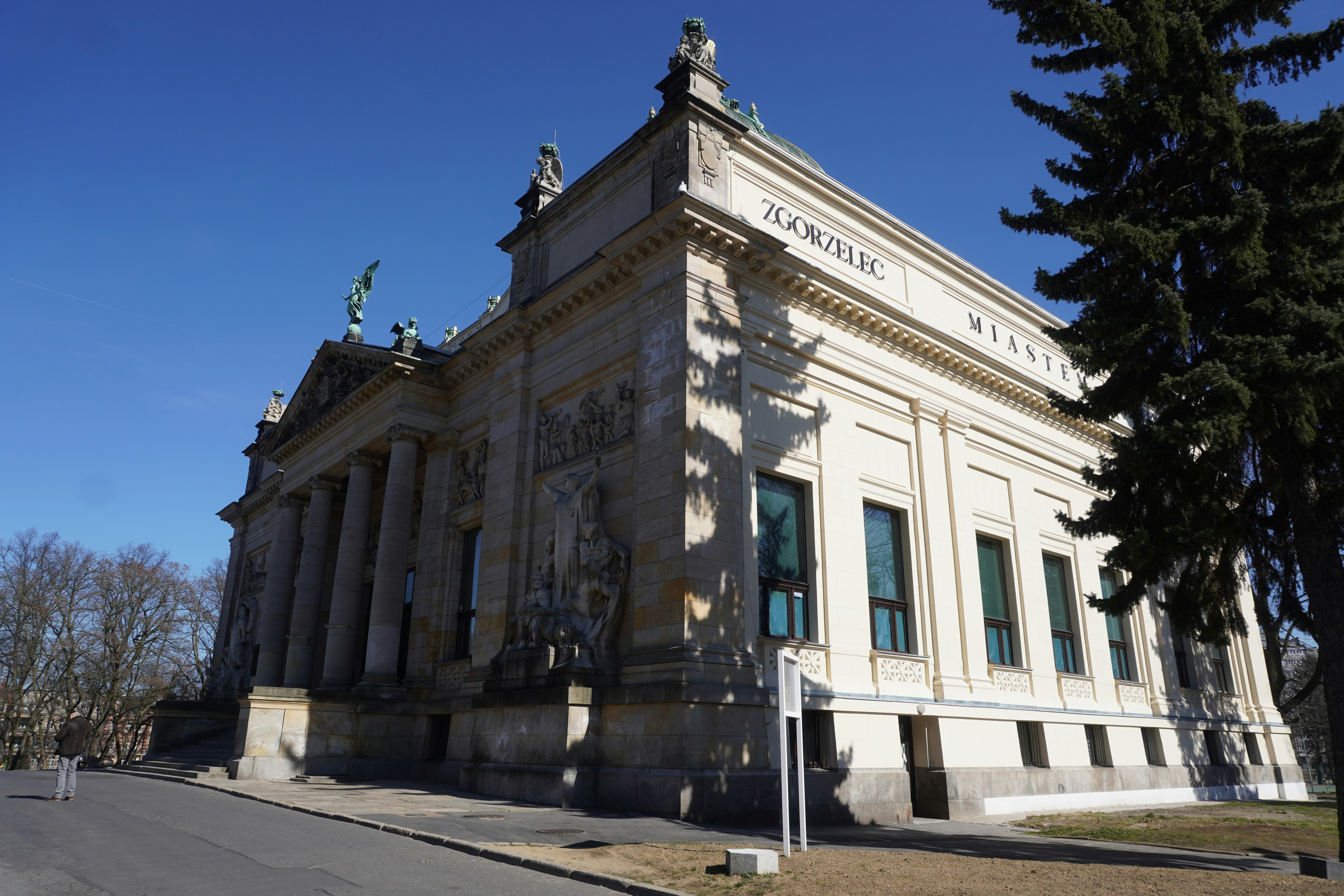 Ornate historical building with grand columns and detailed stonework under a clear blue sky.