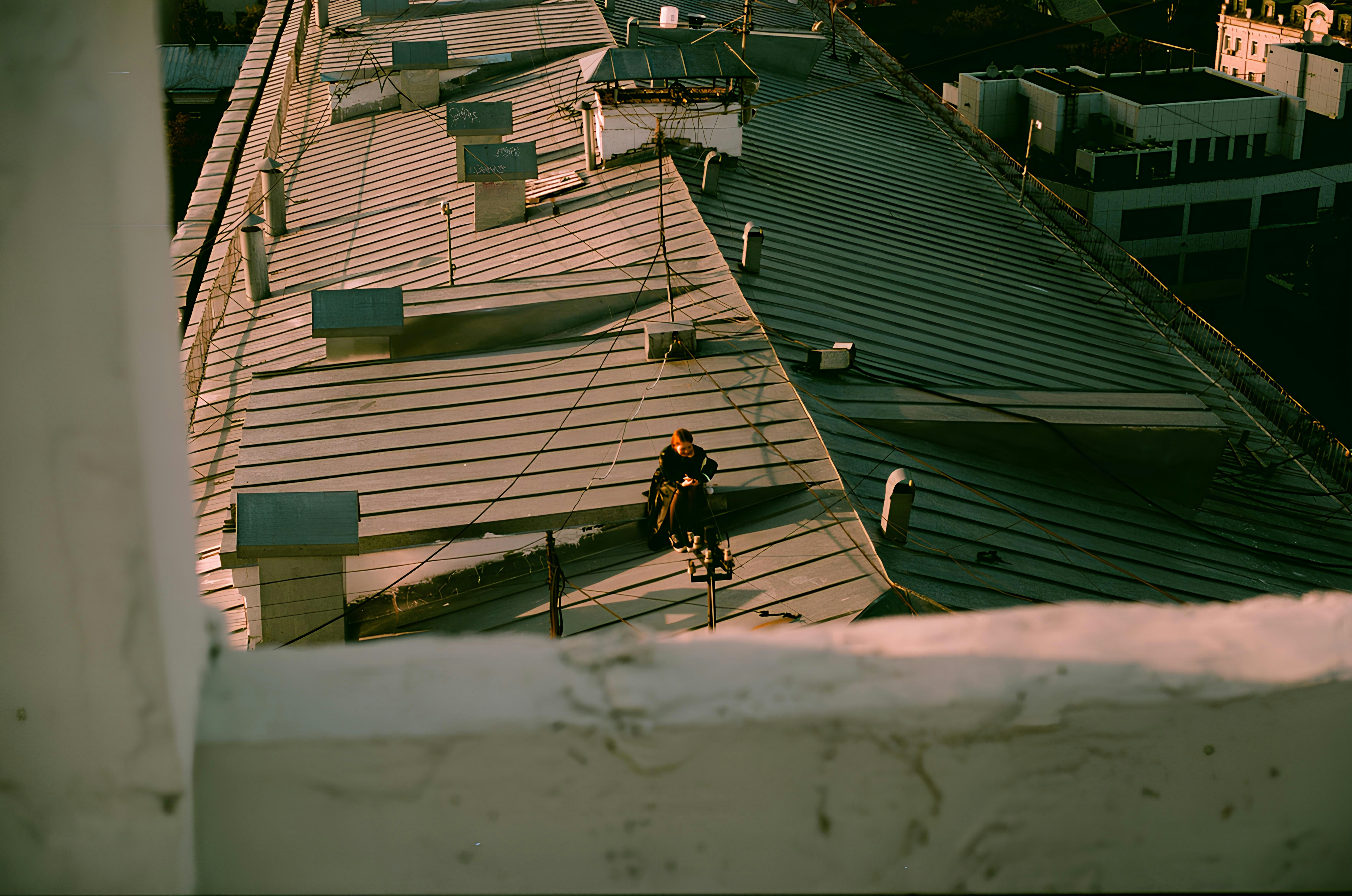 A man riding a bike on top of a roof photo – Free Moscow Image on Unsplash