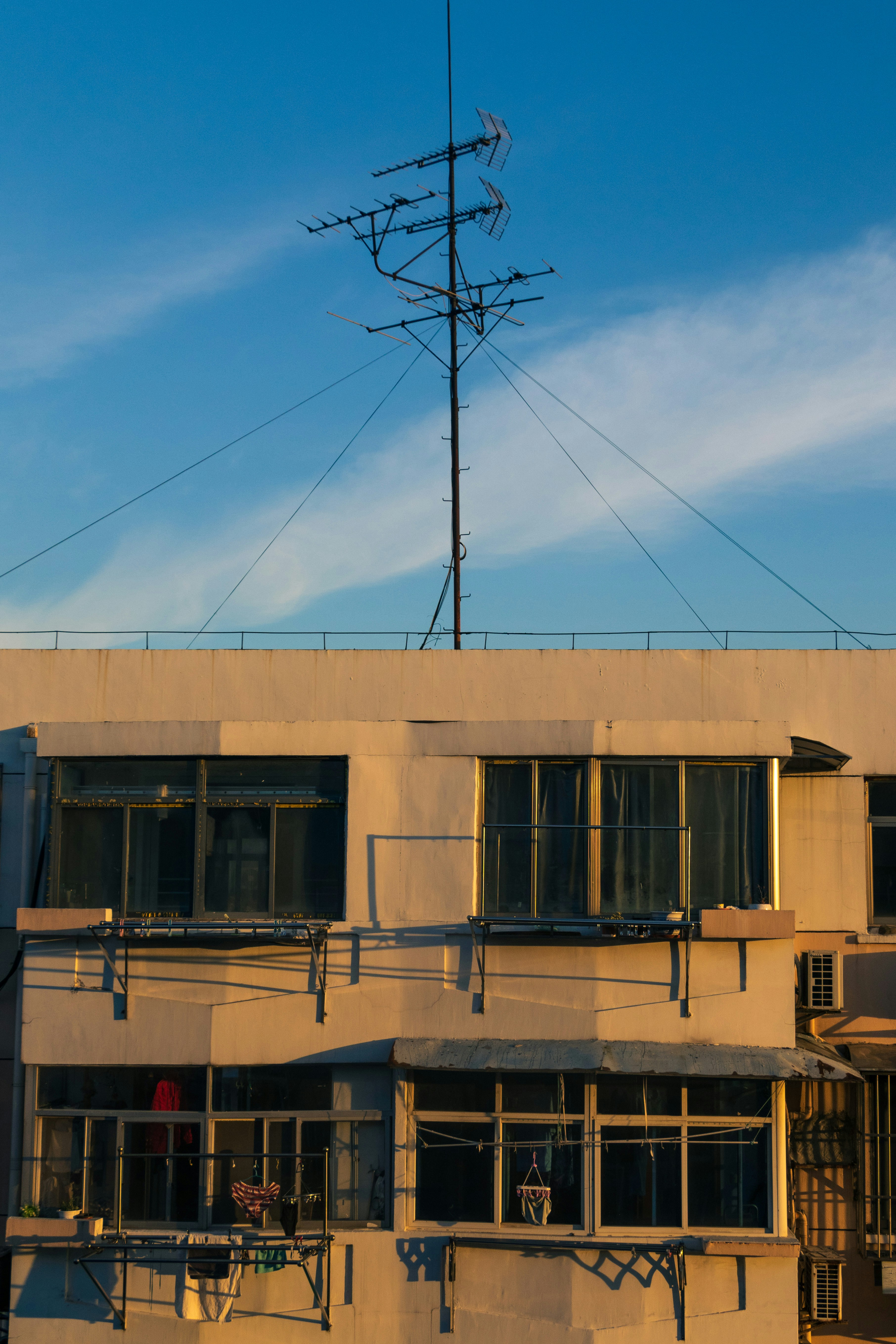 Rooftop Mast Silhouette Against a Cerulean Sky