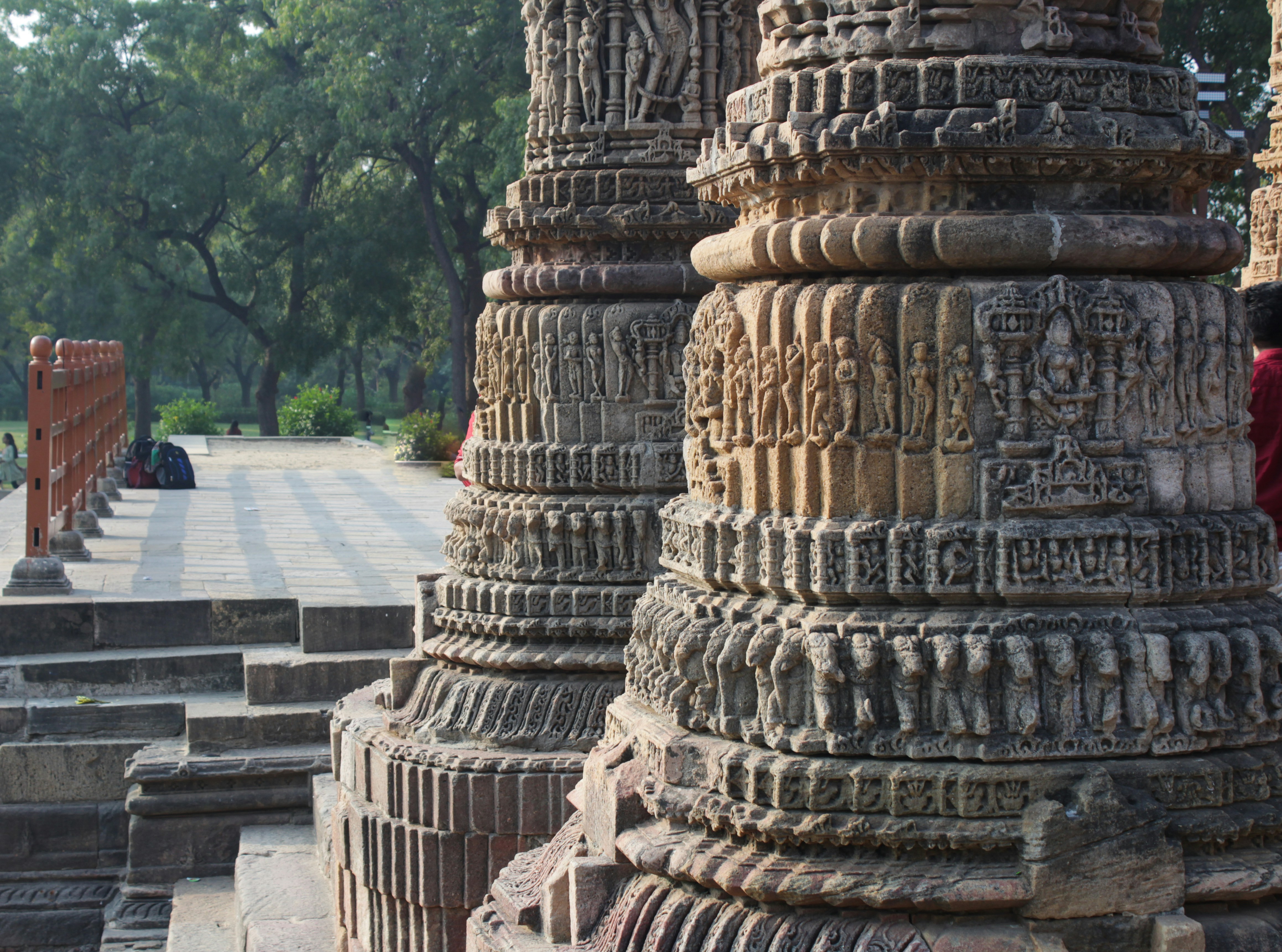 a strong view of insane carving present at the temple.. | a group of stone pillars sitting next to each other