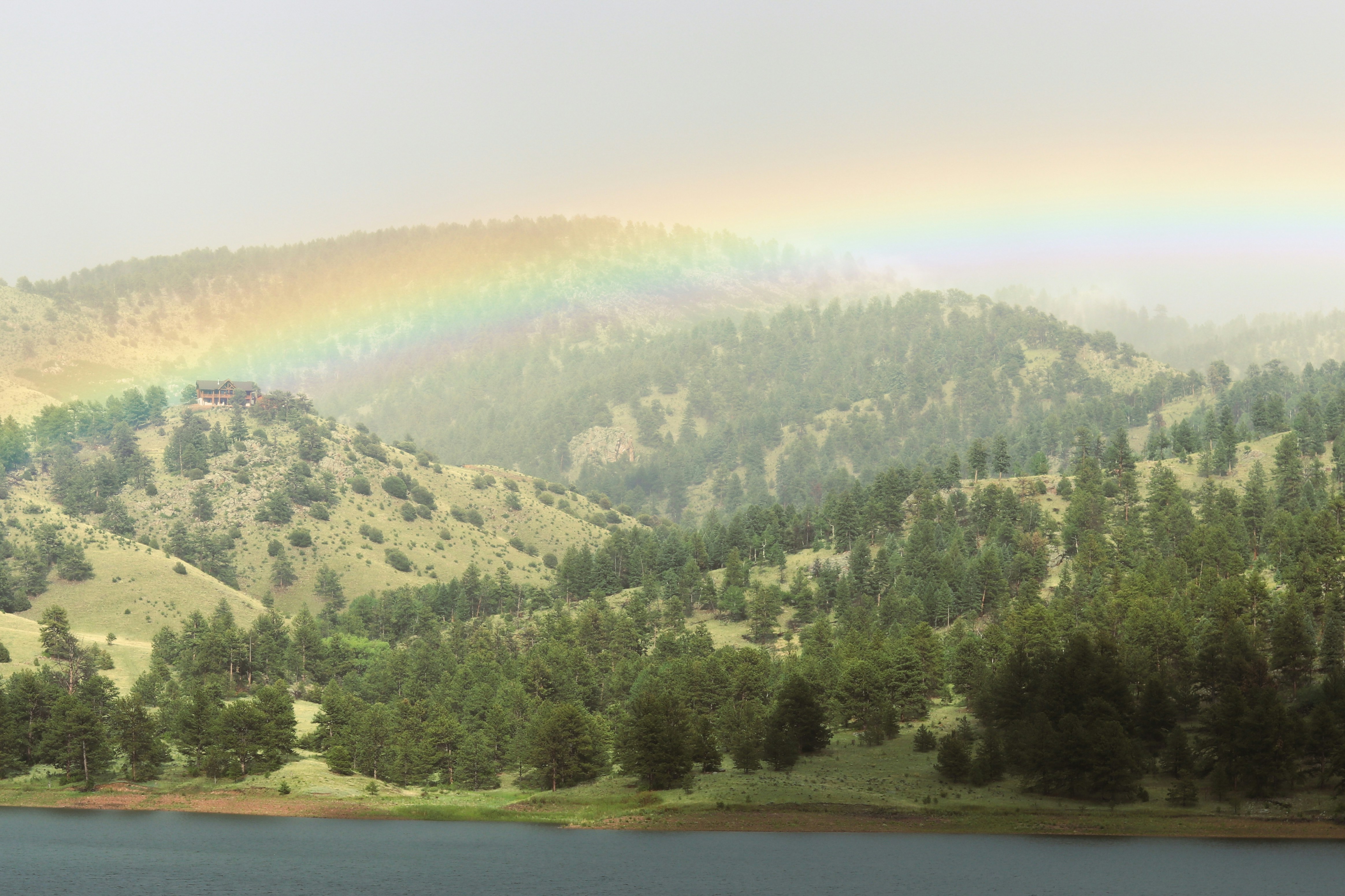 A rainbow in the sky over a mountain range photo – Free Colorado Image ...