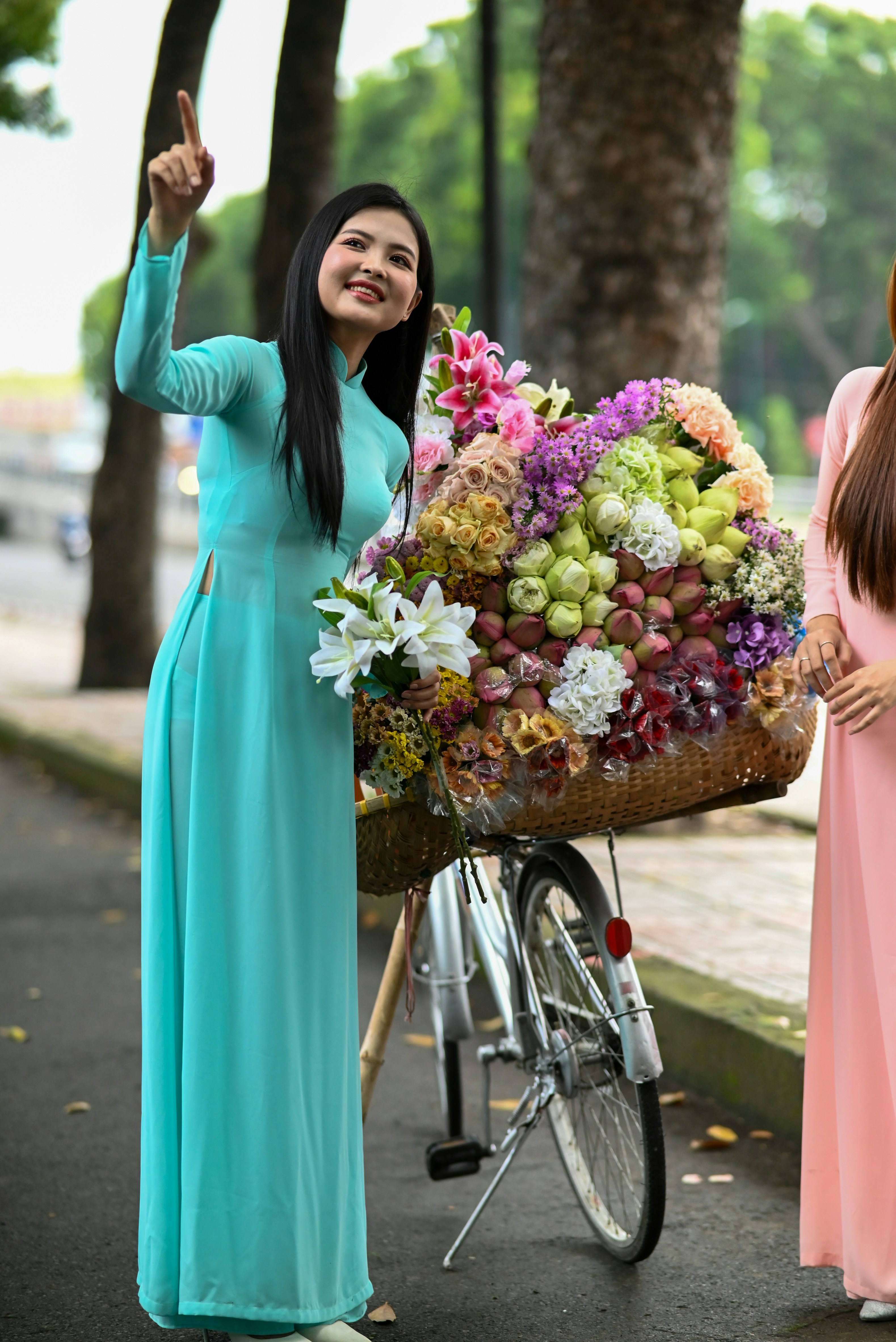 Turquoise Ao Dai by a Blooming Bicycle: A Street-Side Portrait of Color and Motion