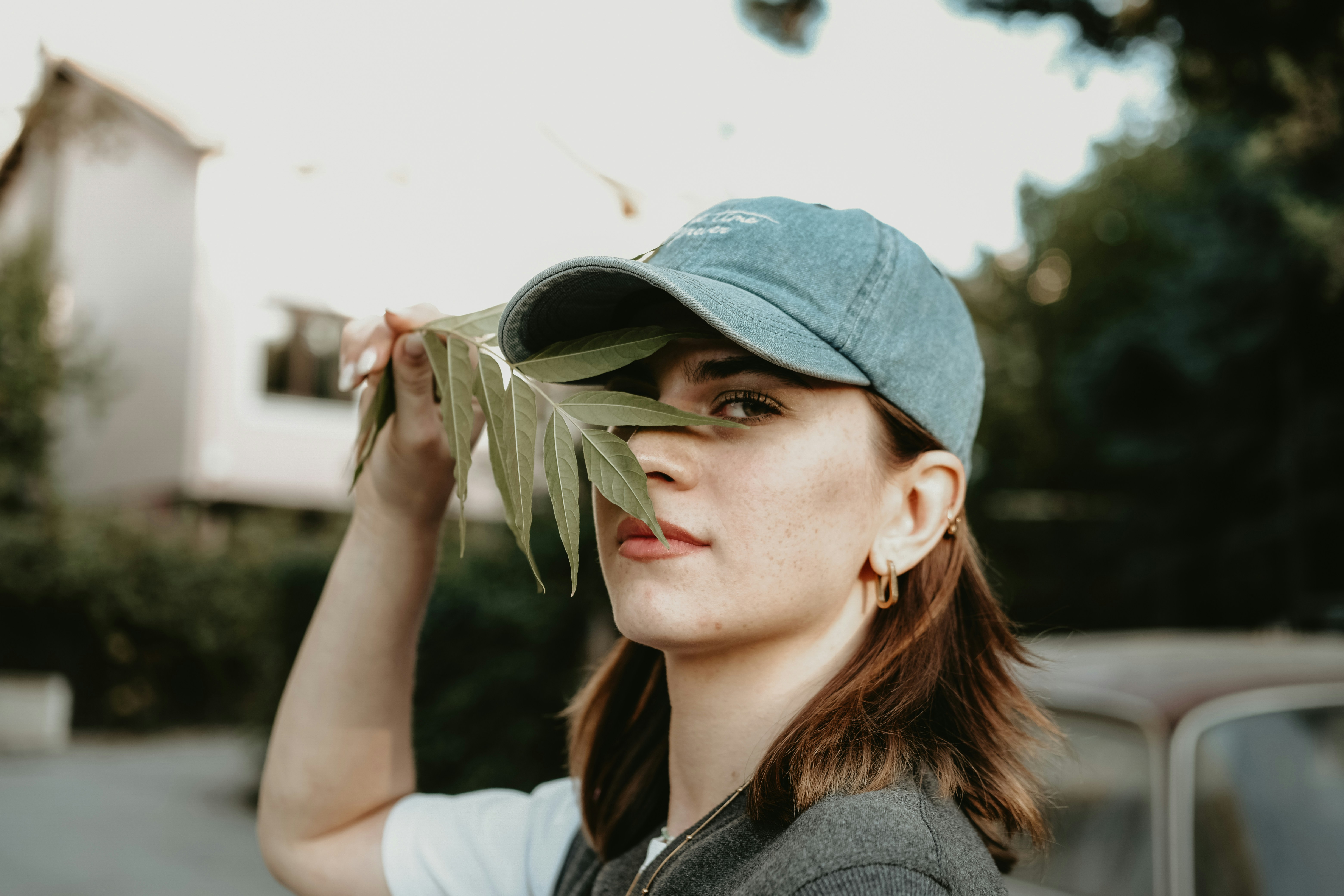 Leaf-Frame Portrait Under a Cerulean Cap