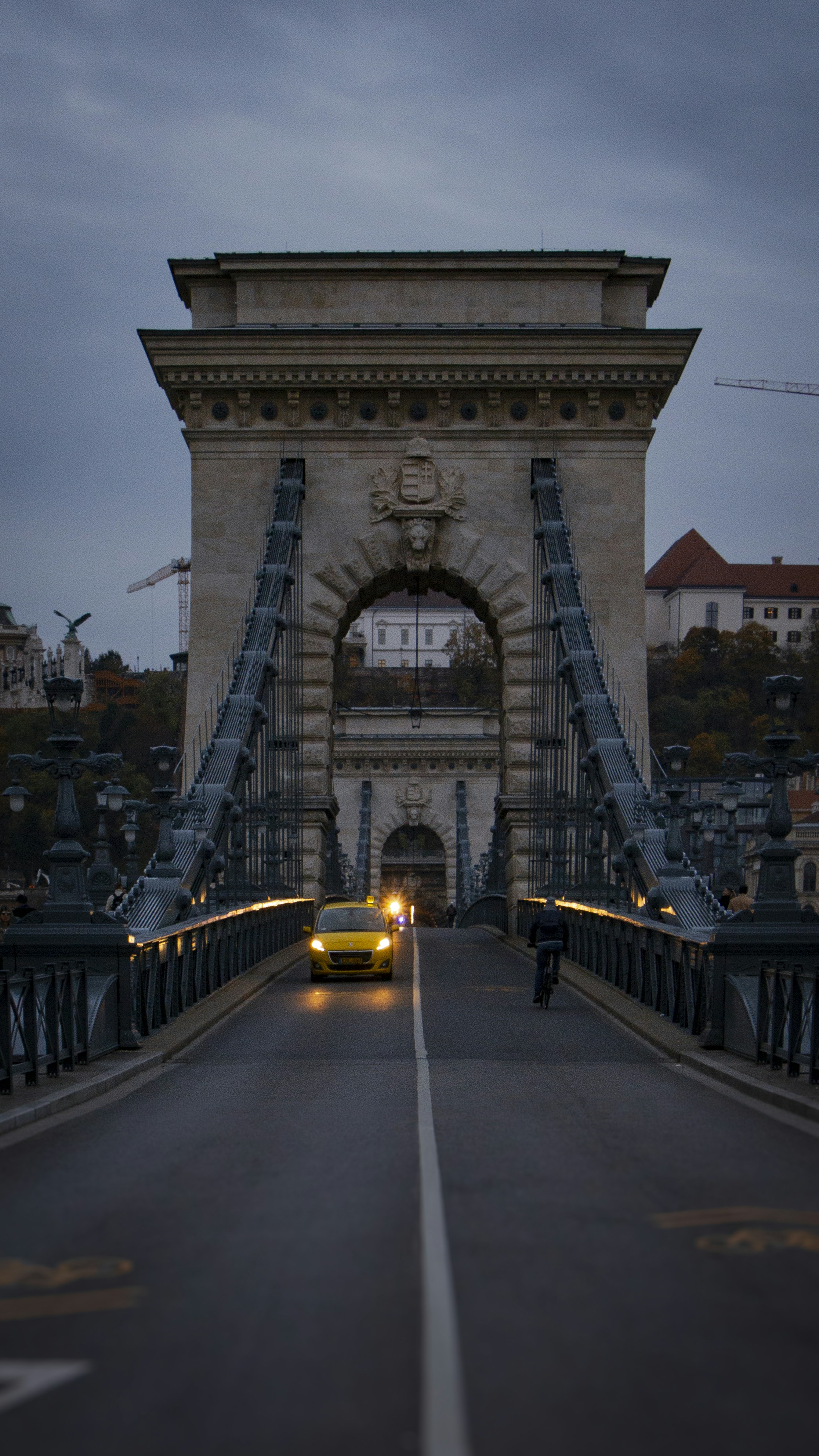Yellow Car at the Arc: Dusk Crossing on the Chain Bridge