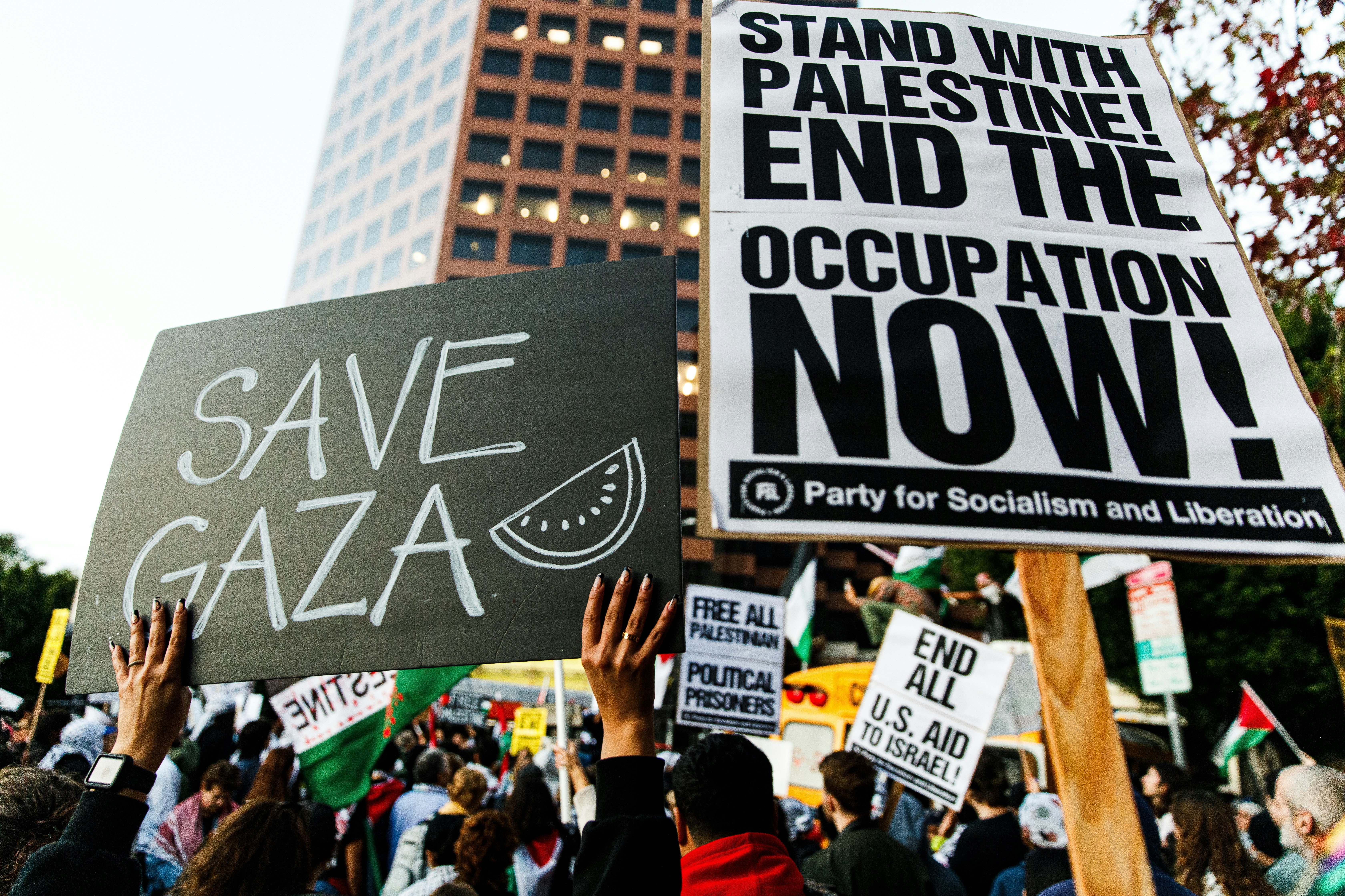 A group of people holding up protest signs photo – Free Parade Image on ...