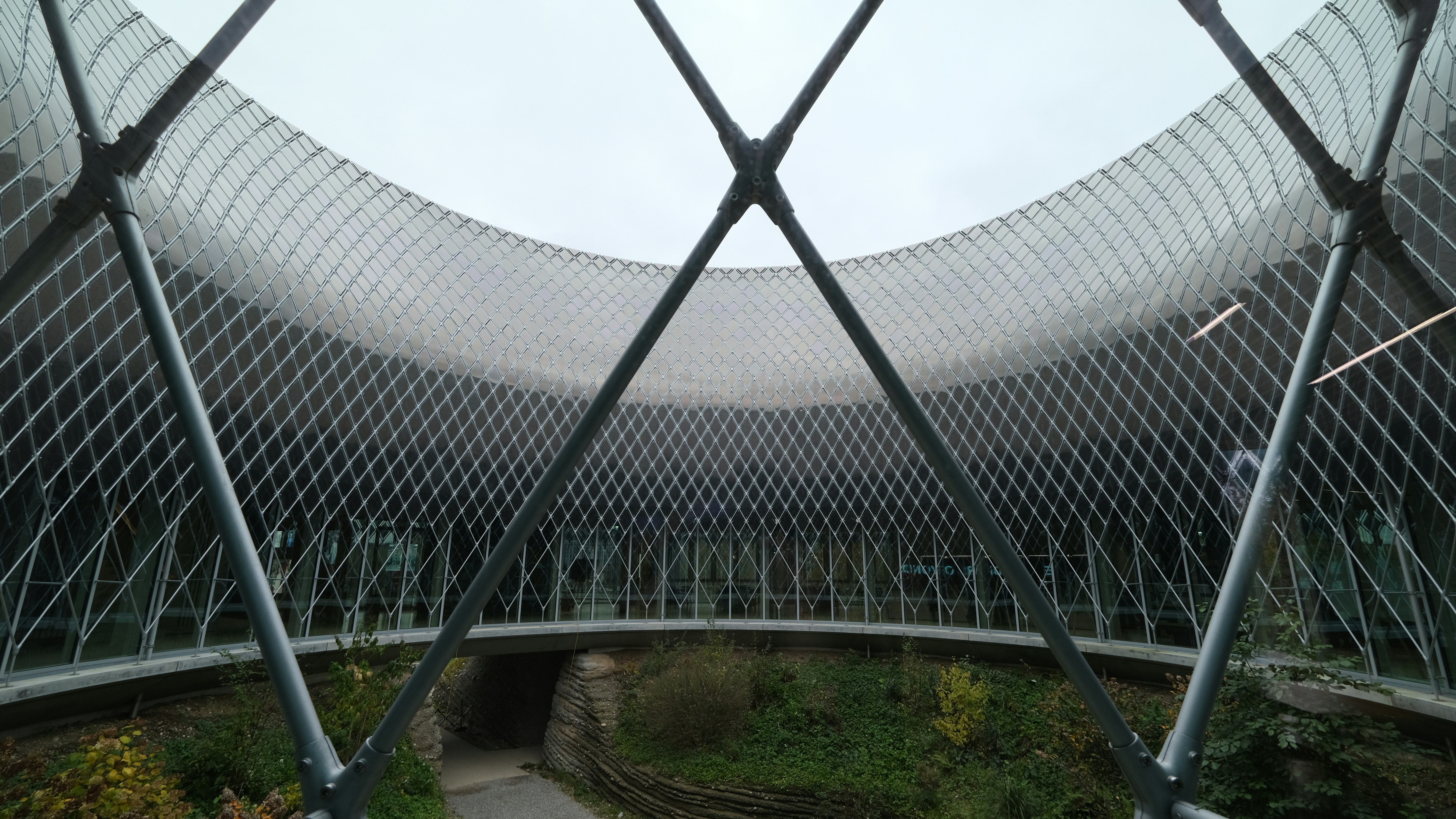 A circular building with a walkway going through it photo – Free Basel ...