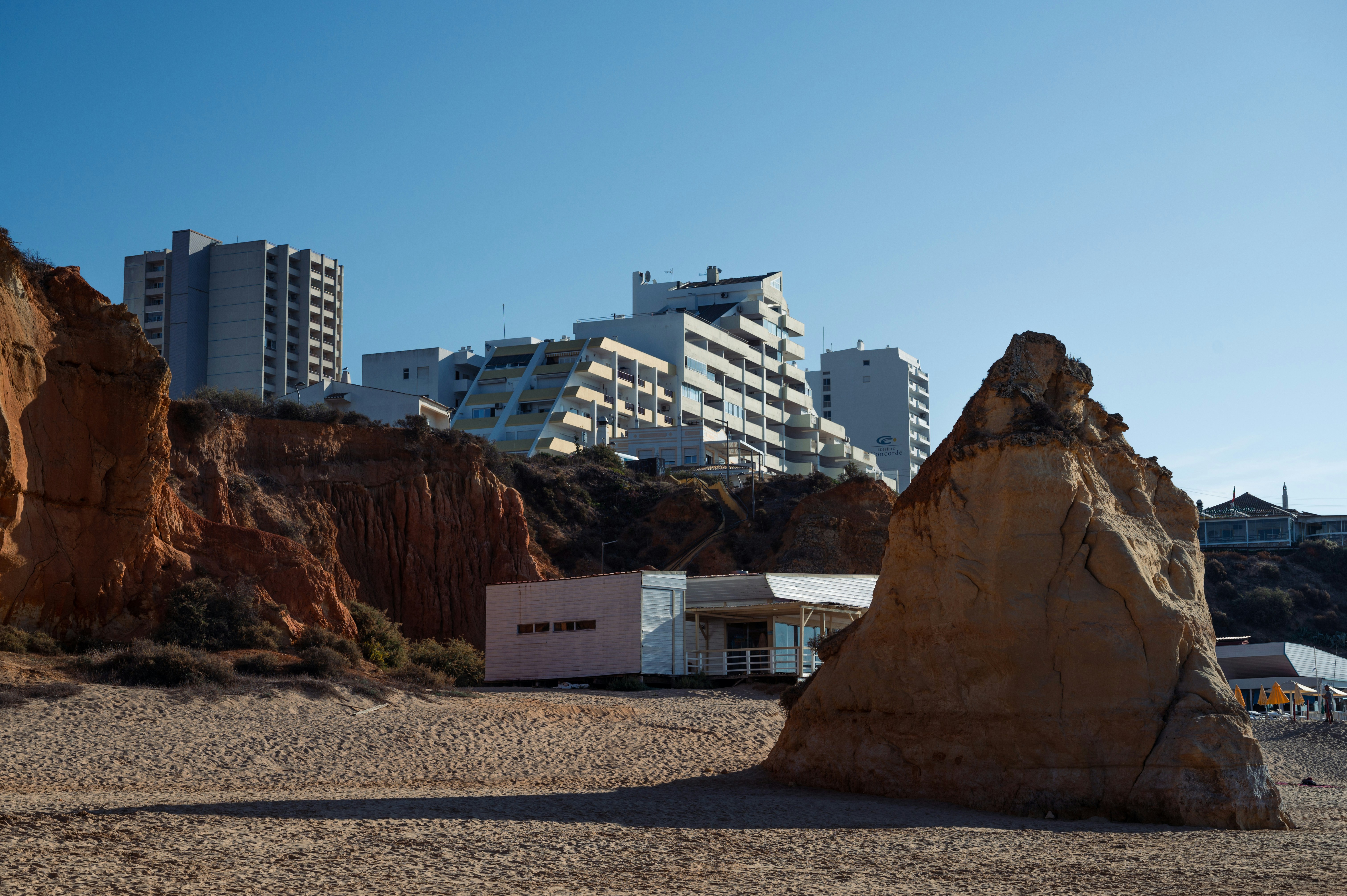 a large rock sitting on top of a sandy beach