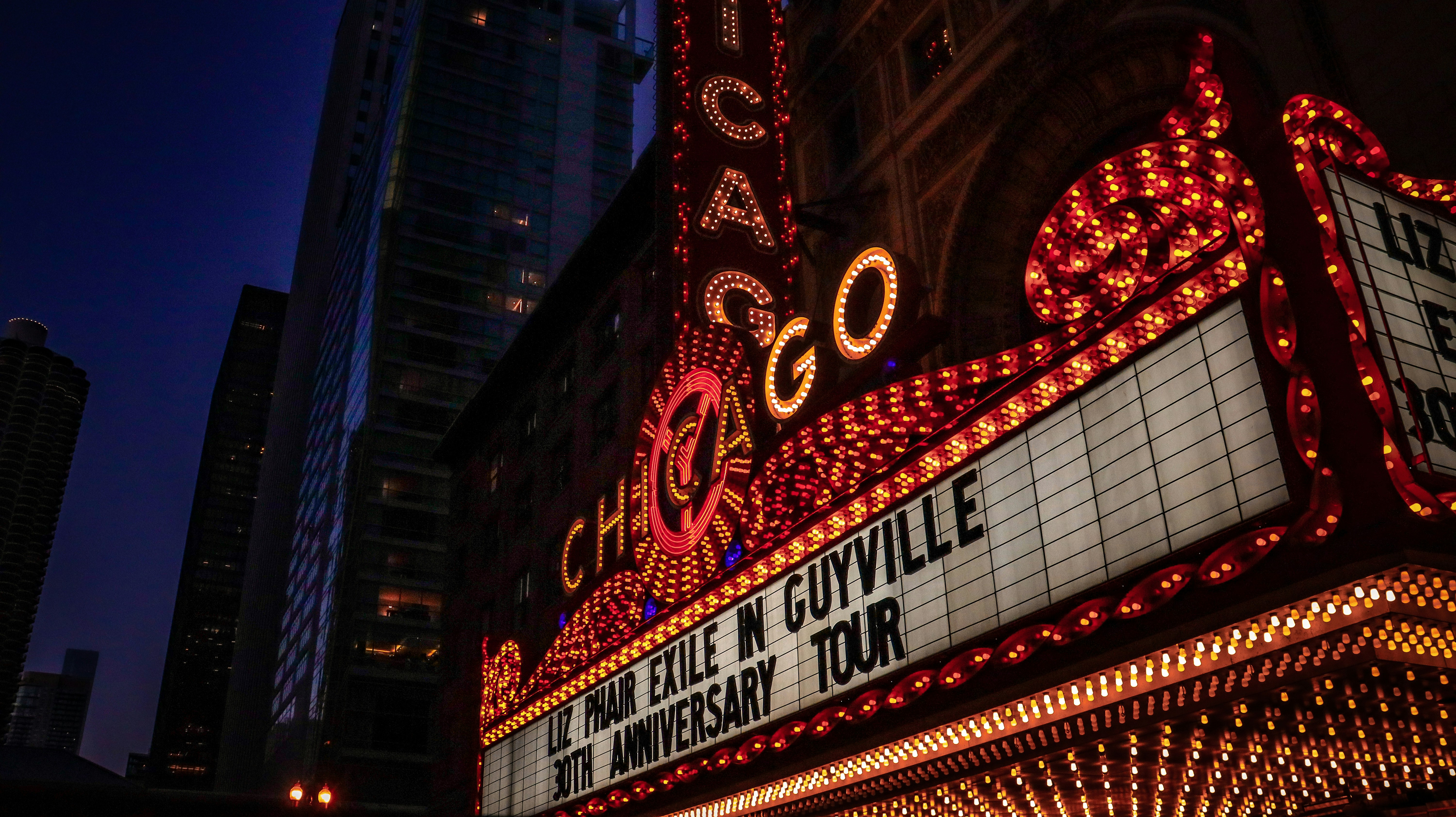 A theater marquee with lights and a clock on it photo – Free City Image ...
