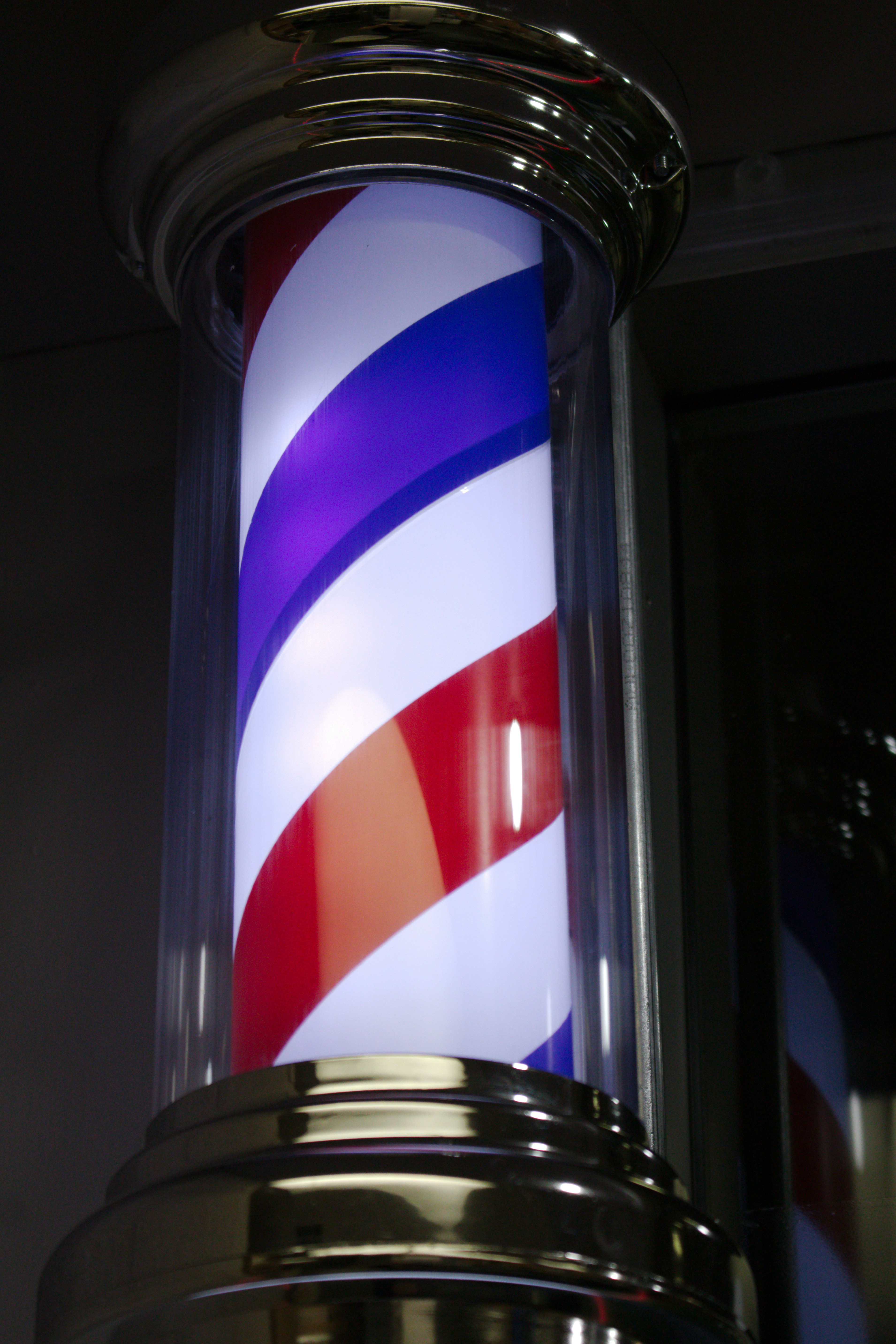 Barber-pole centerpiece: chrome column framing a spiraling red, white, and blue twist