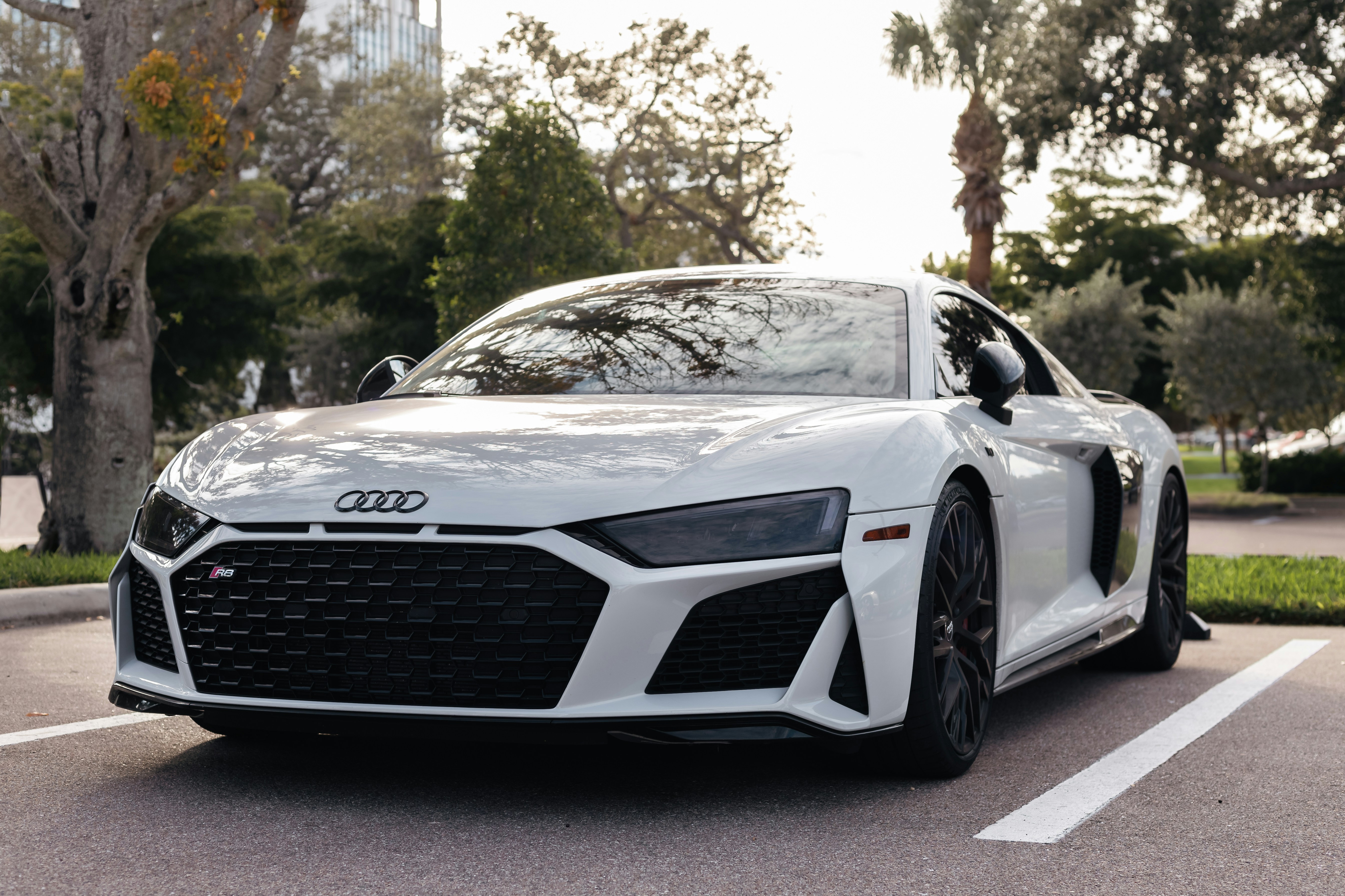 A white sports car parked in a parking lot photo – Free Audi r8 Image ...