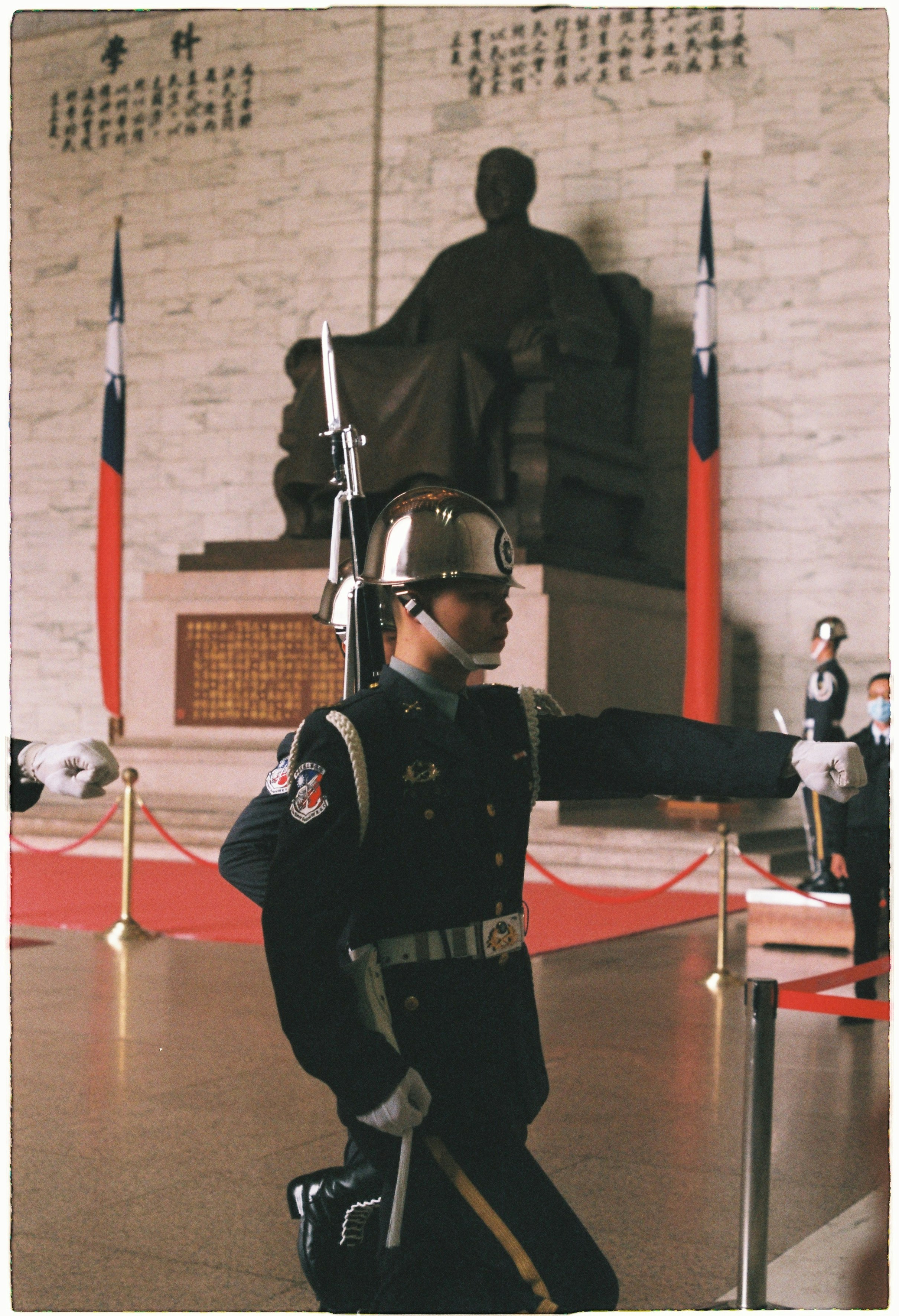 A man in uniform standing in front of a statue photo – Free Portrait ...
