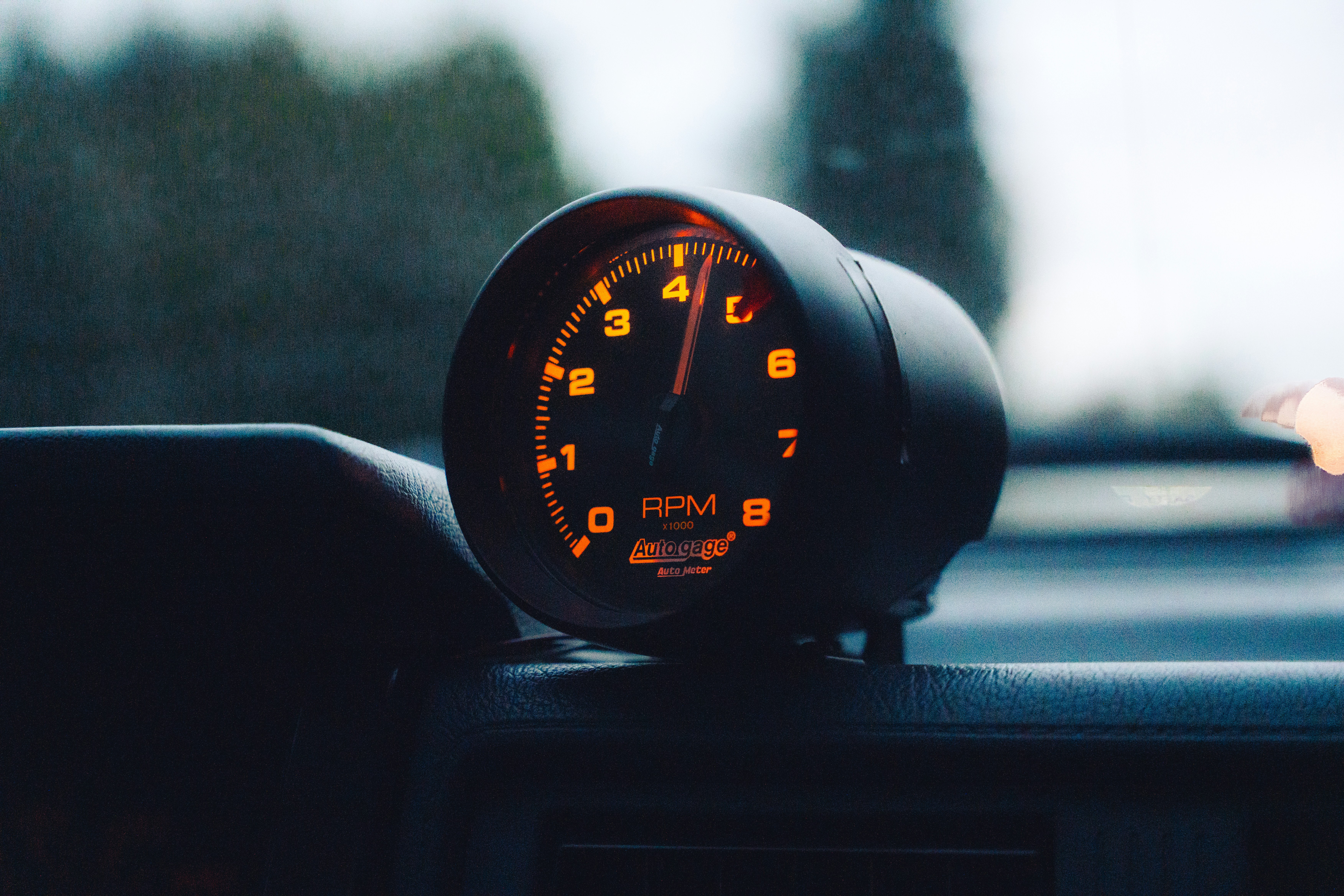 Amber RPM Dial: A Quiet Car Dashboard in Sharp Focus