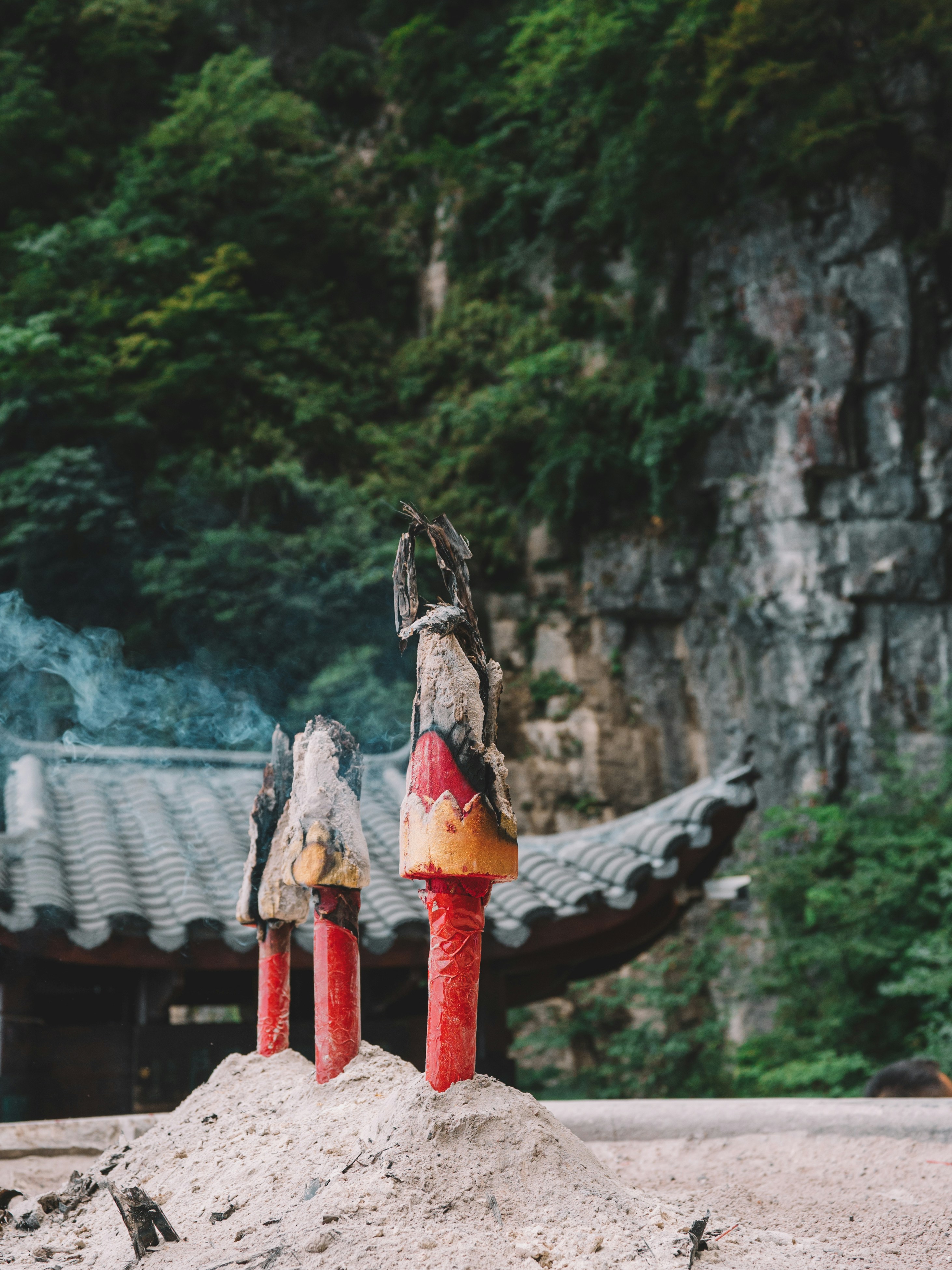 A couple of red fire hydrants sitting on top of a pile of dirt photo ...