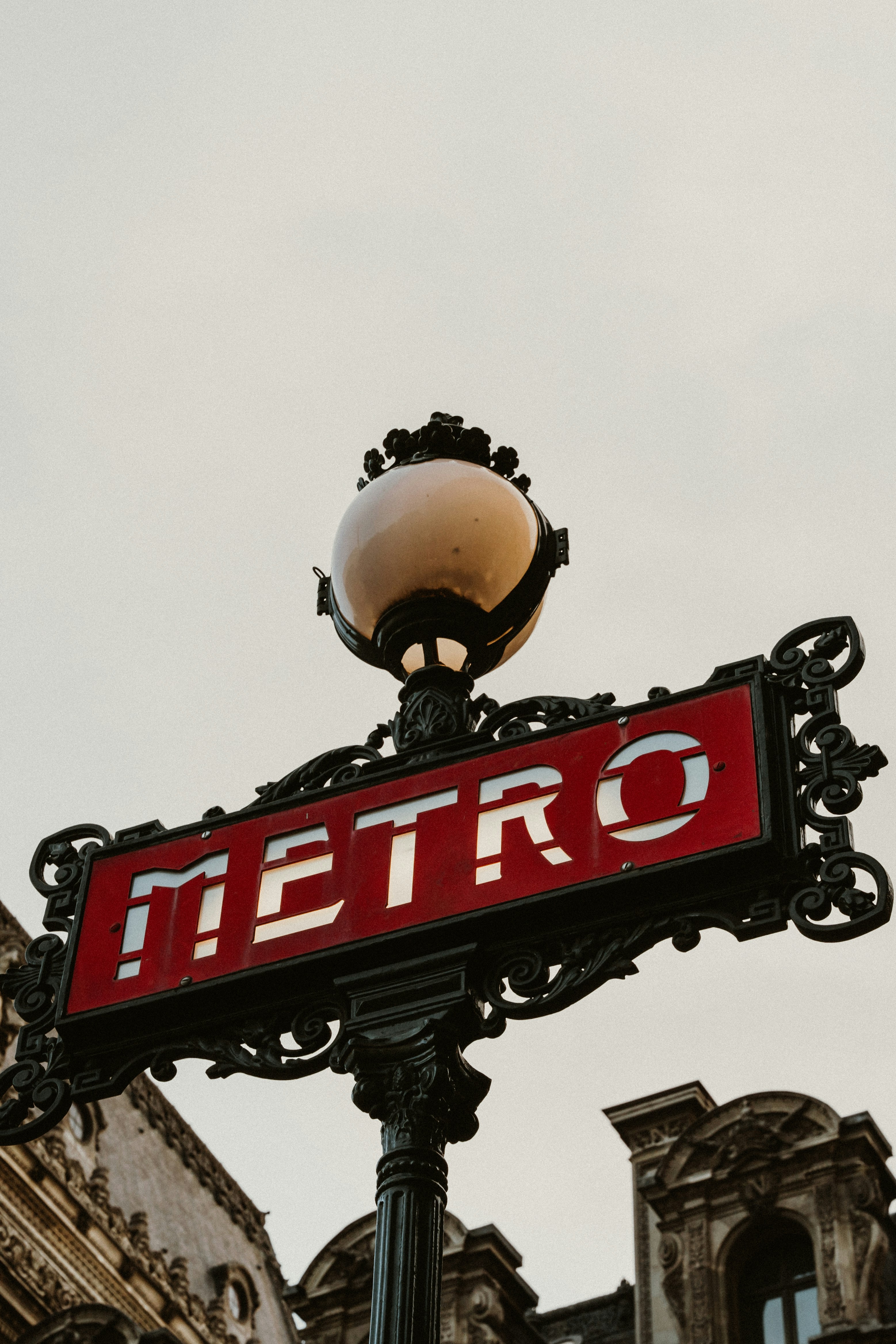 A red metro sign on top of a lamp post photo – Free Brown Image on Unsplash
