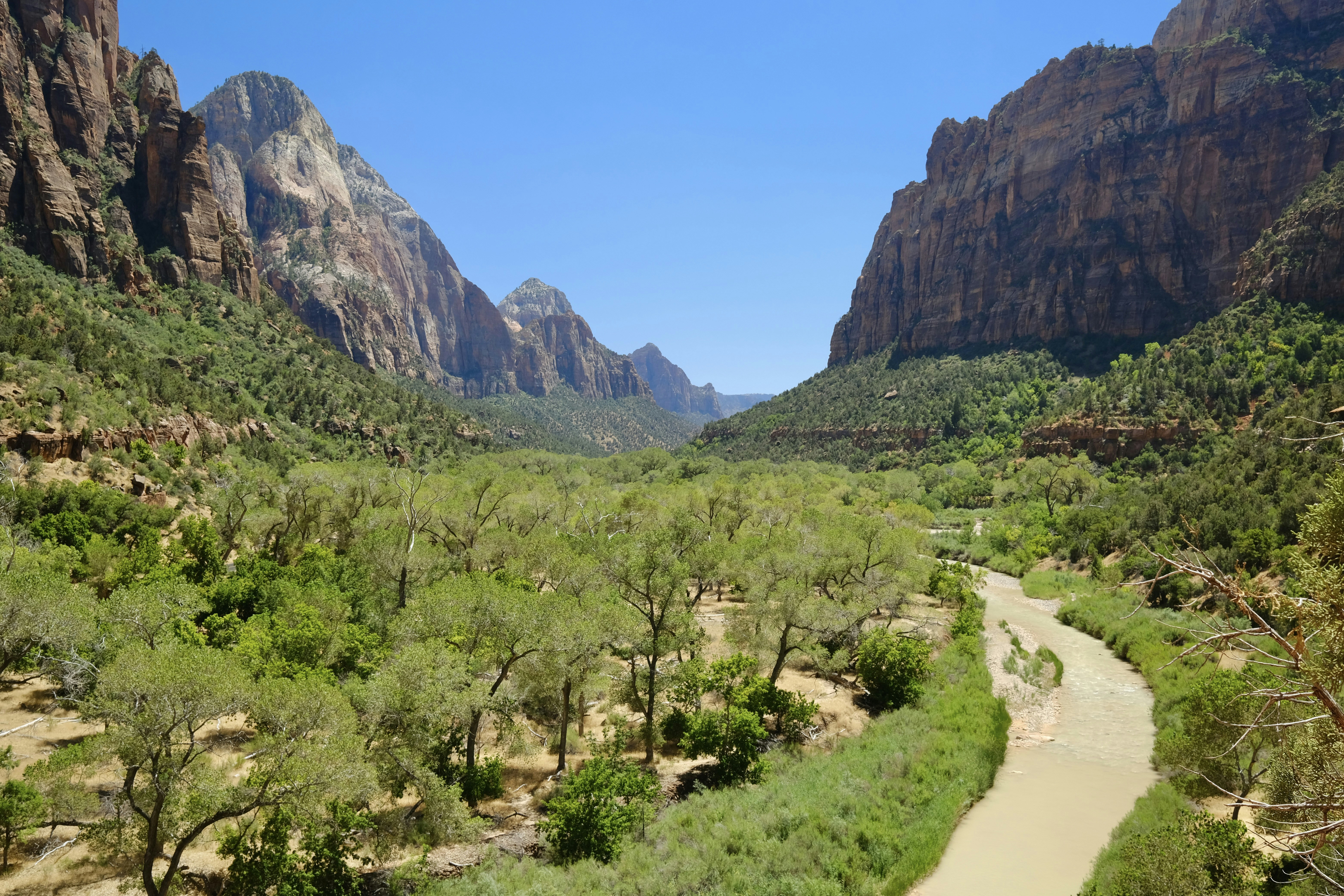 A river running through a lush green valley photo – Free Mountain Image ...