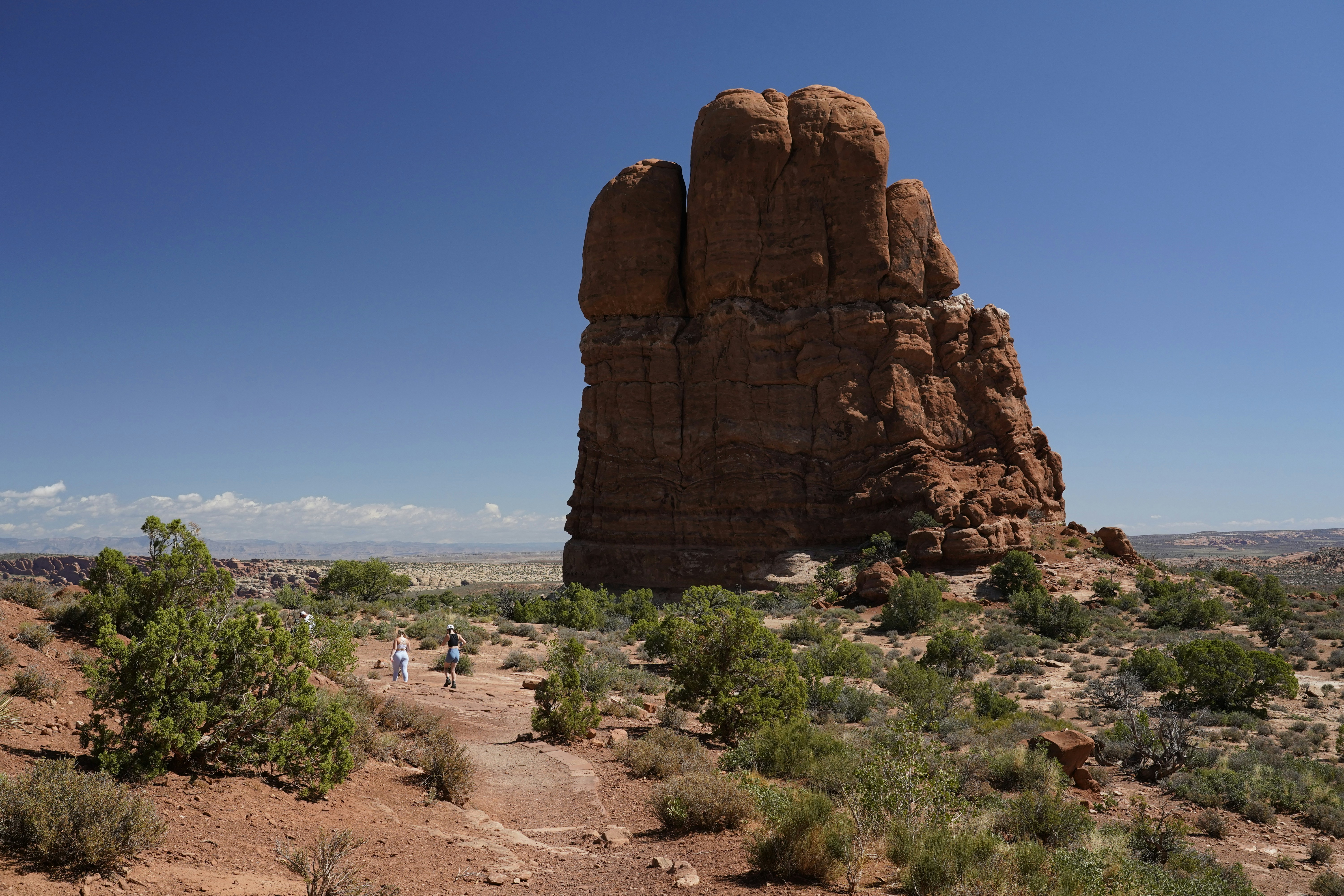 The Sentinel of the Desert: A Giant Red Rock Over a Winding Trail