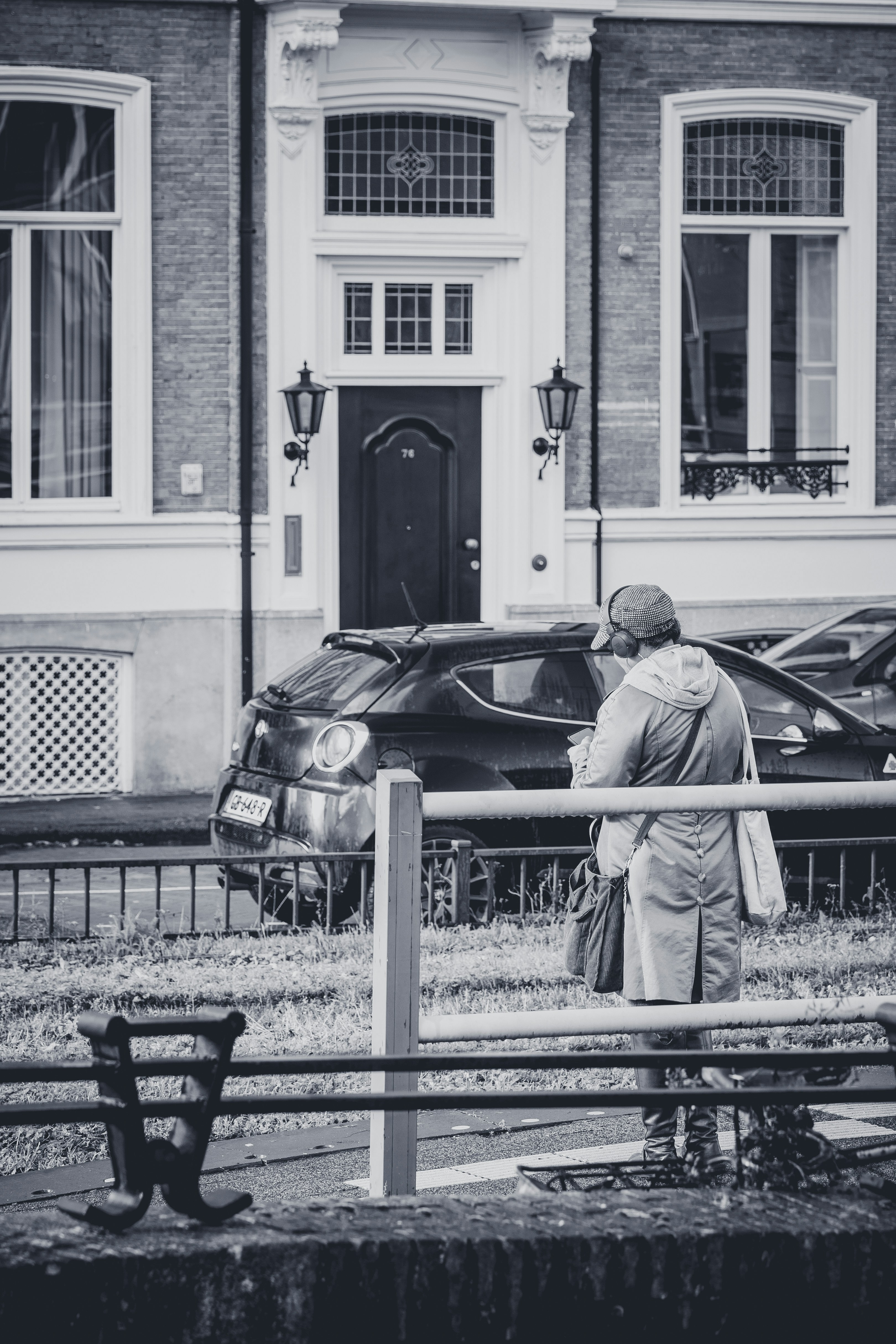 Georgian Street Pause: A Figure by a Parked Car Under Street Lamps