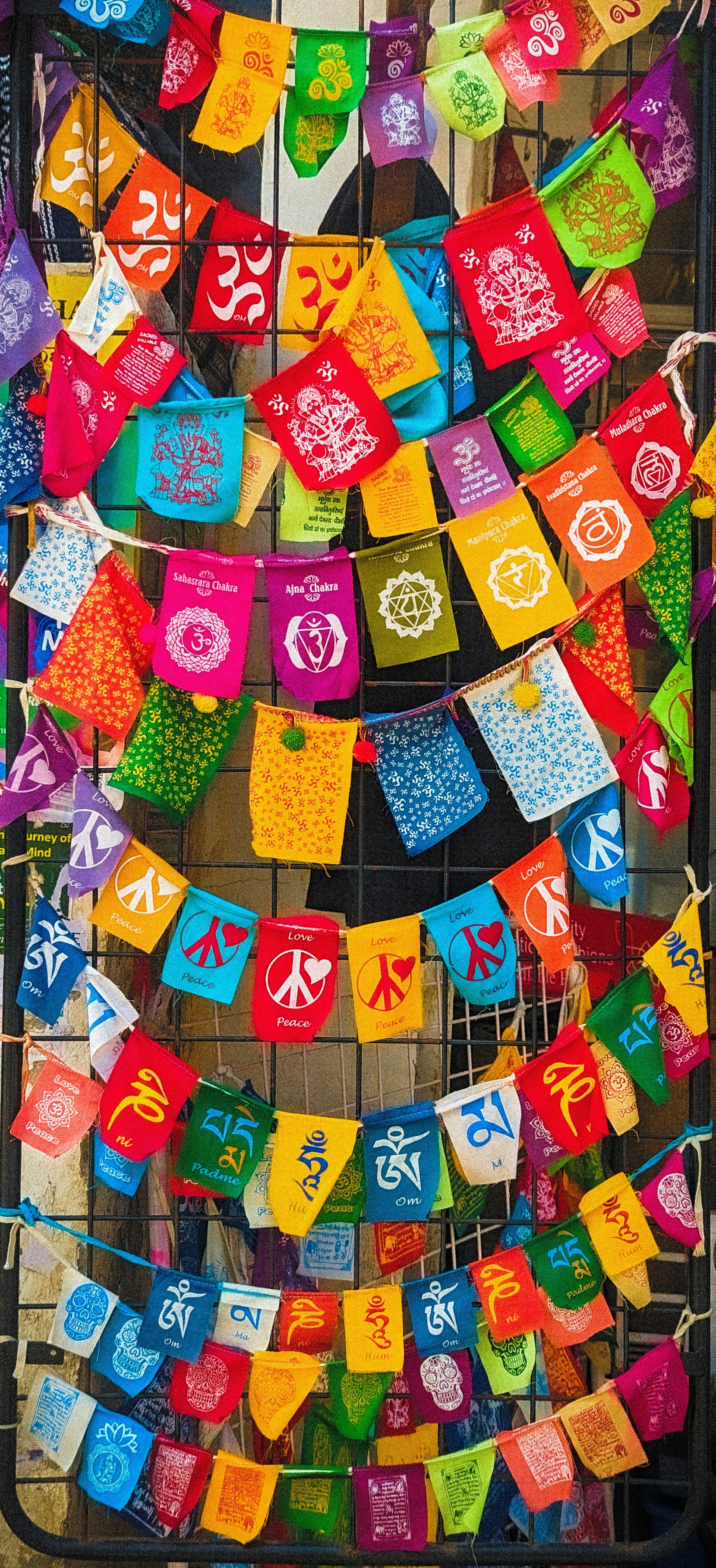 Colorful Prayer Flags Draped Over a Metal Grid