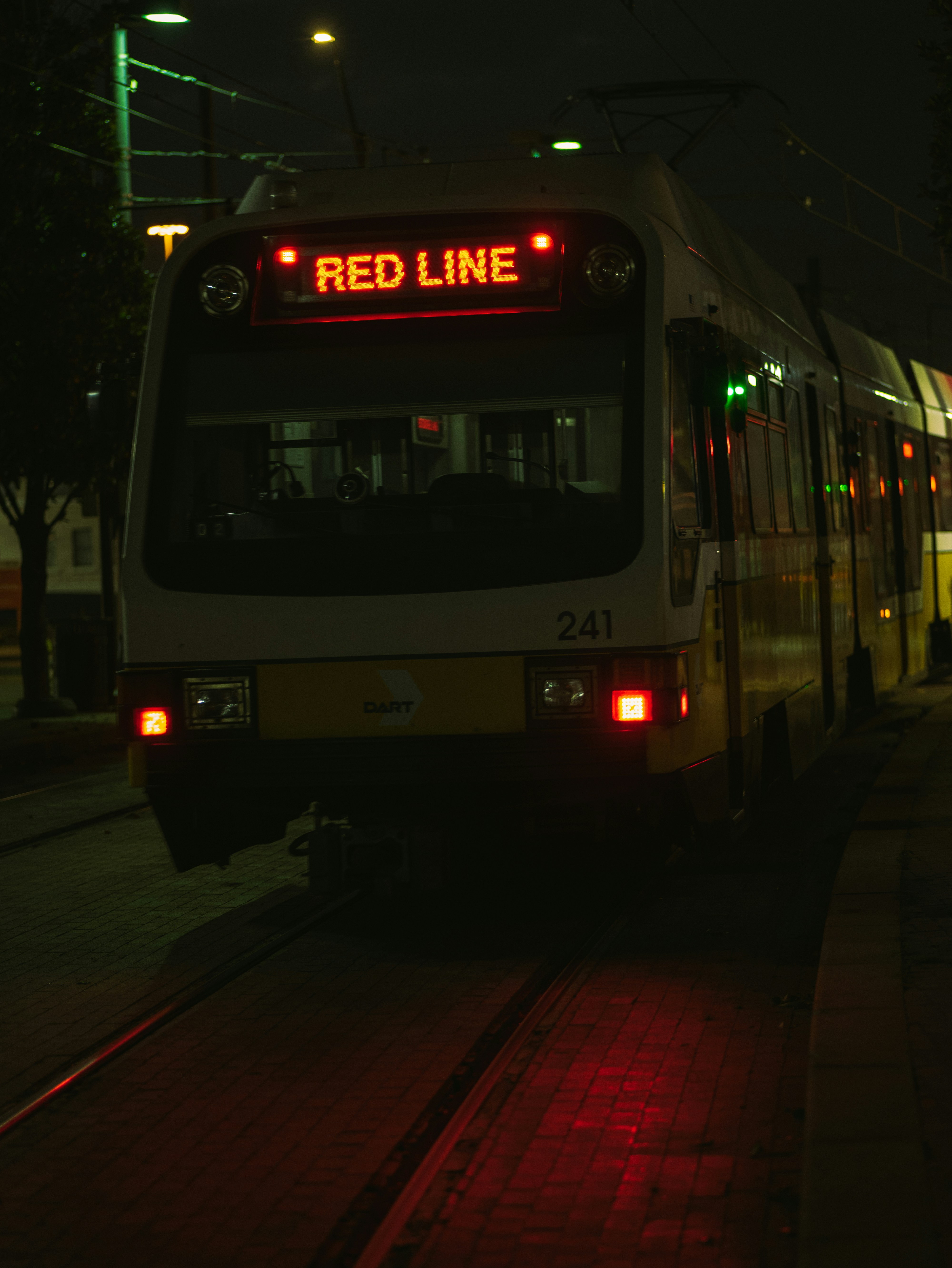 A red line train on the tracks at night photo – Free Usa Image on Unsplash