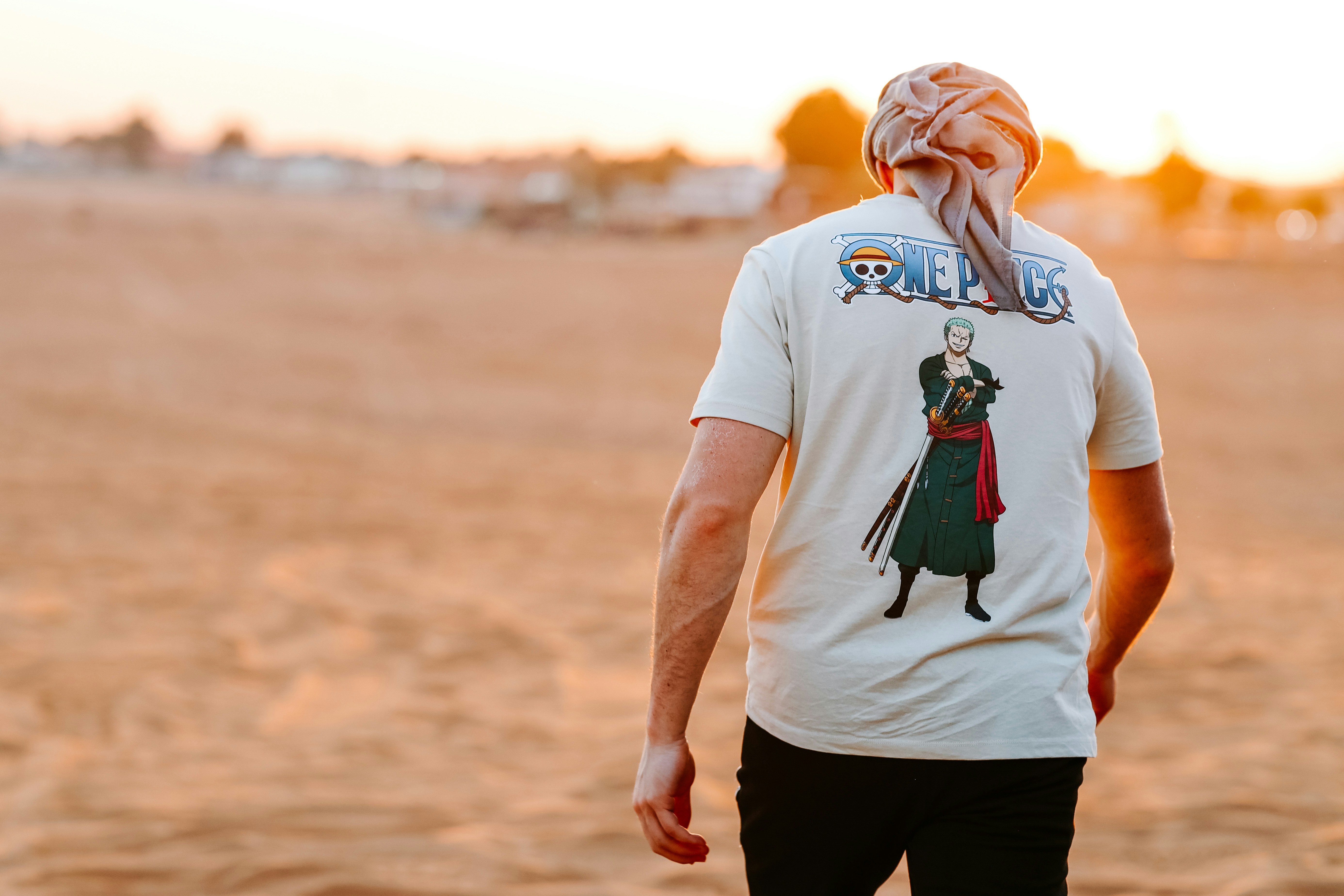 Back to the Sunset: One Piece Graphic Tee on a Quiet Beach