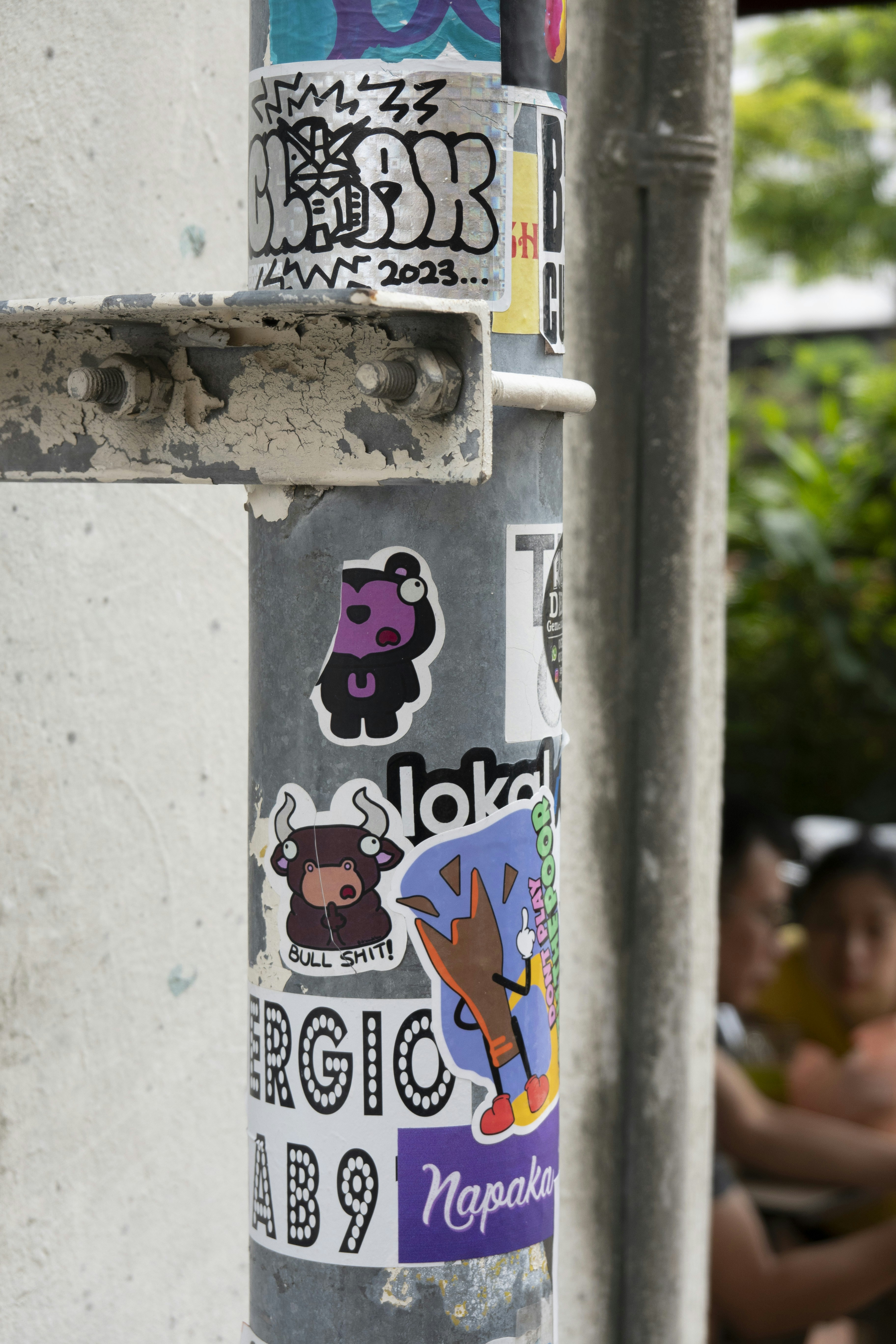 a pole with a bunch of stickers on it