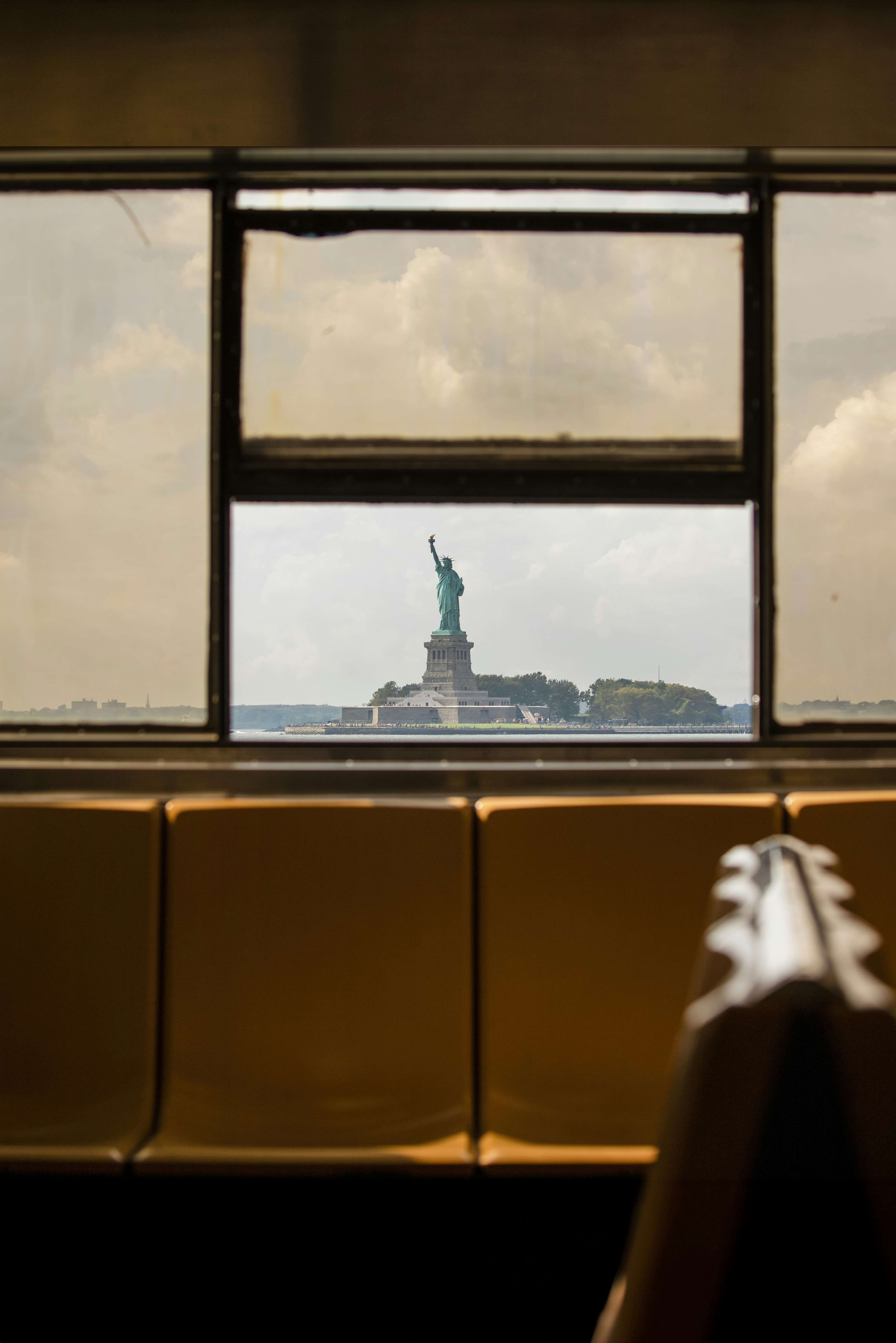 A view of the statue of liberty through a window photo – Free New york ...