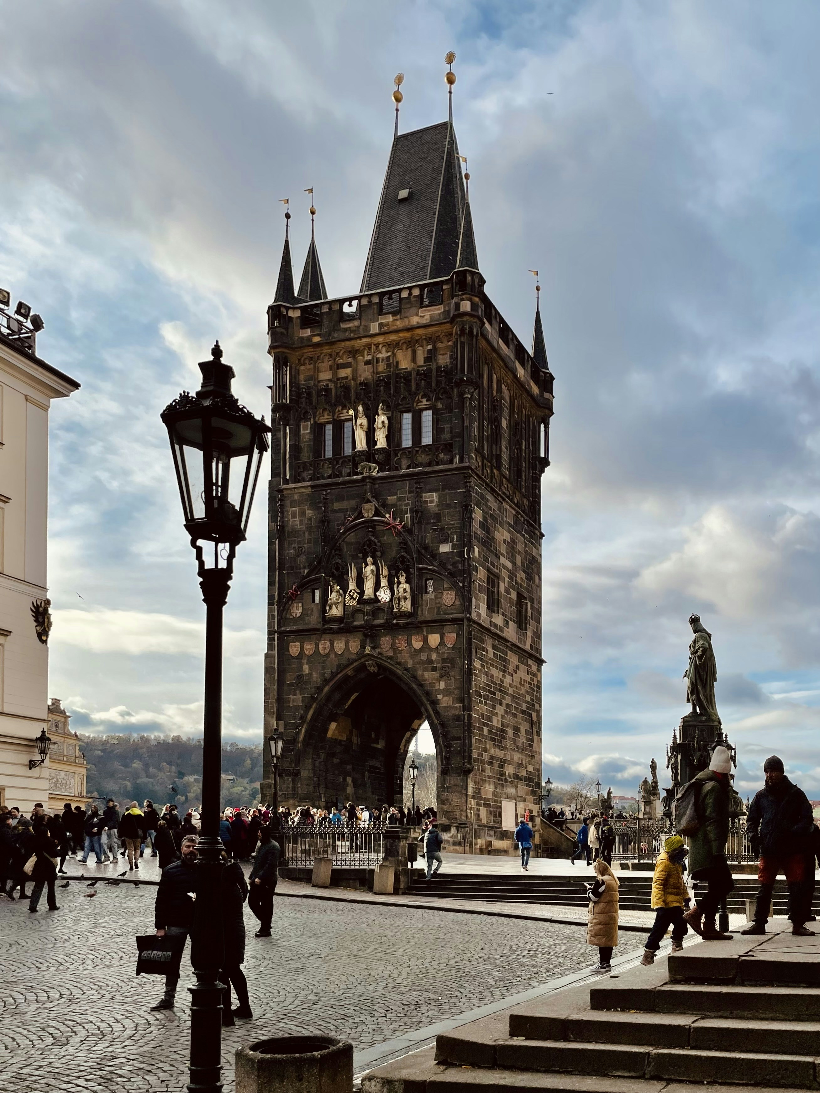 Prague's Stone Sentinel: The Old Town Bridge Tower Over a Busy Square