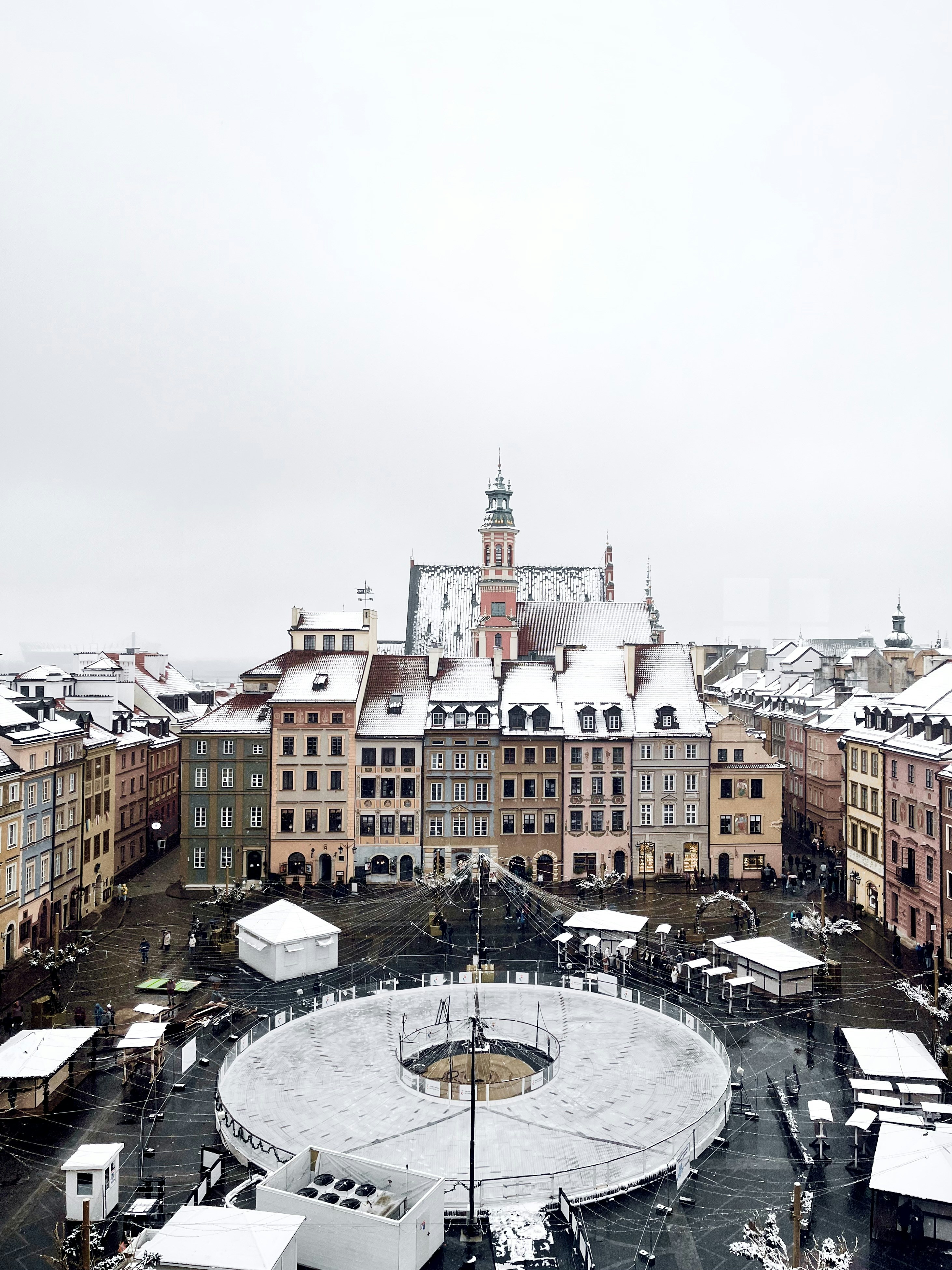 Winter Piazza: A Circular Plaza Framed by Pastel Facades and a Clocktower