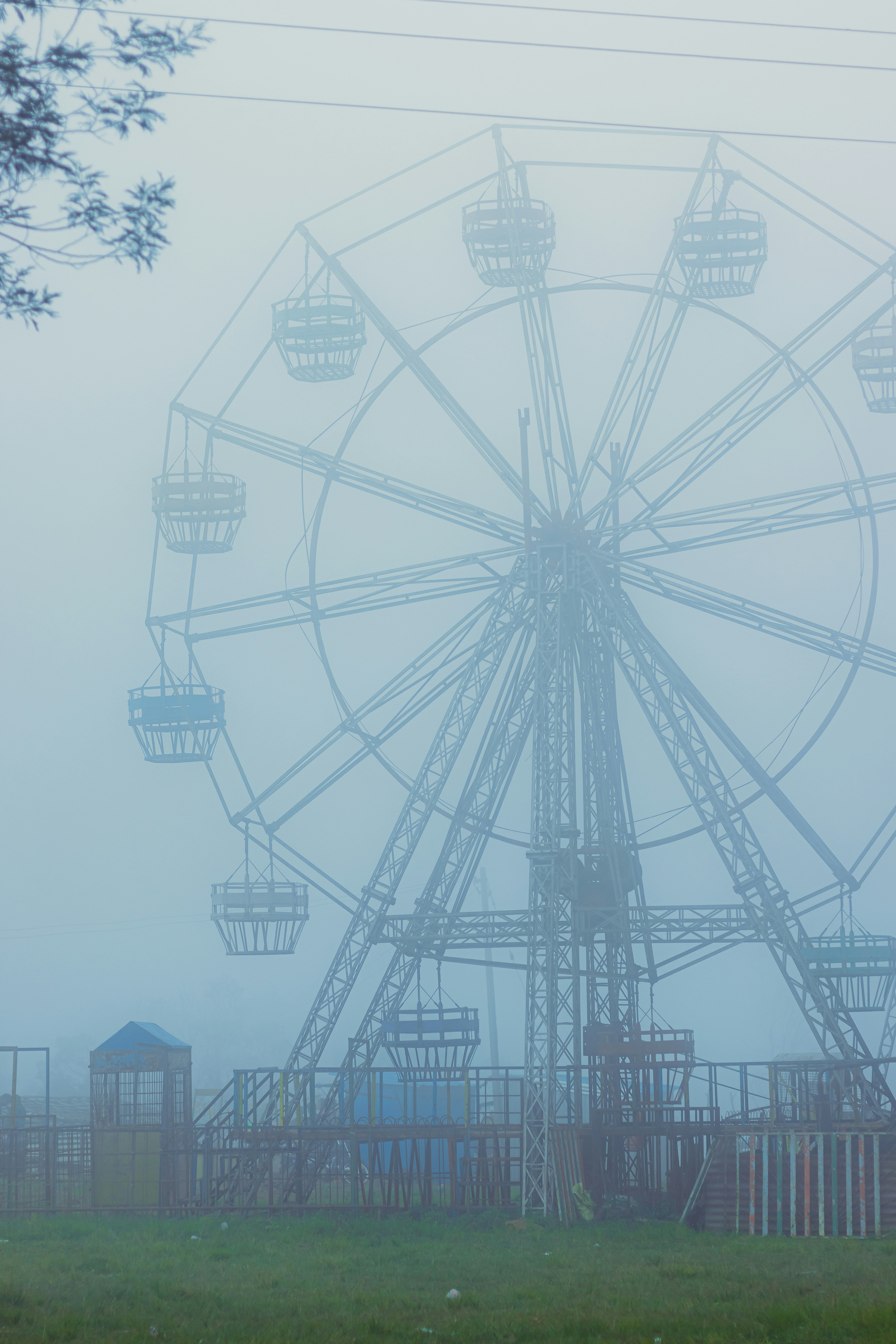Blue Mist Ferris Wheel: A Silent Giant Shrouded by Fog