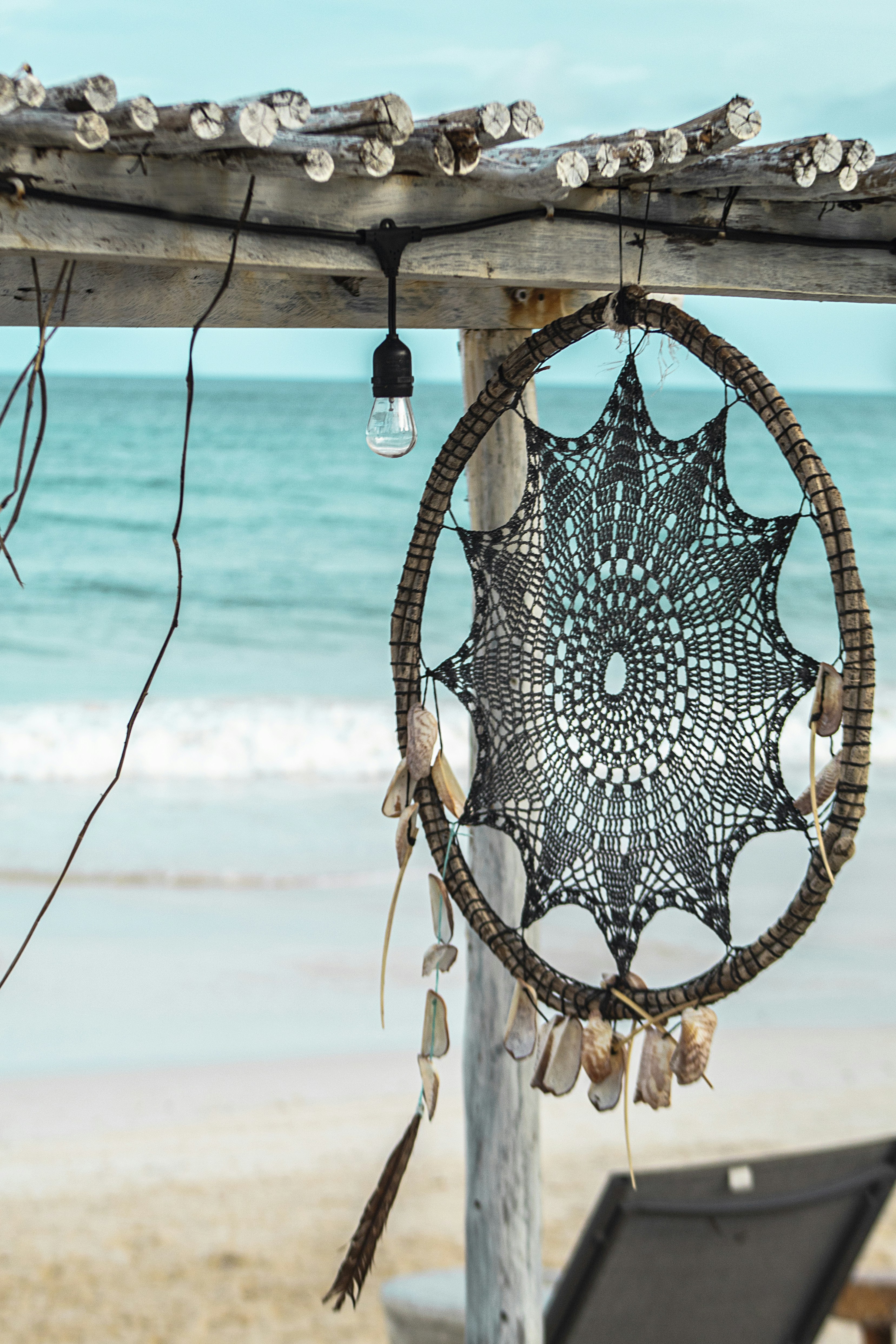 Dreamcatcher on a Turquoise Shore: Threads of Light and Driftwood