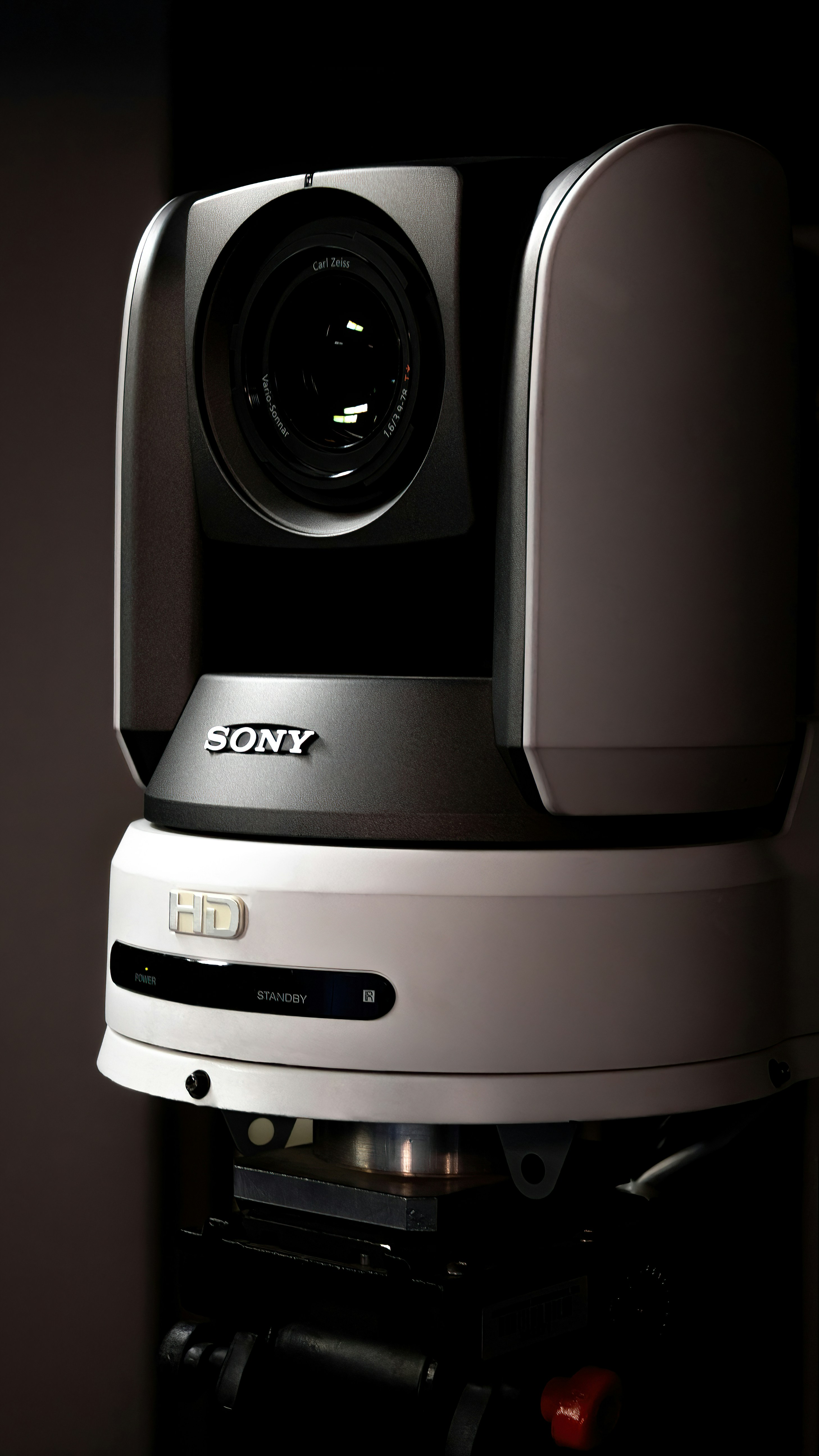 Center Stage: A Sony camcorder head with Carl Zeiss lens under sculpted lighting