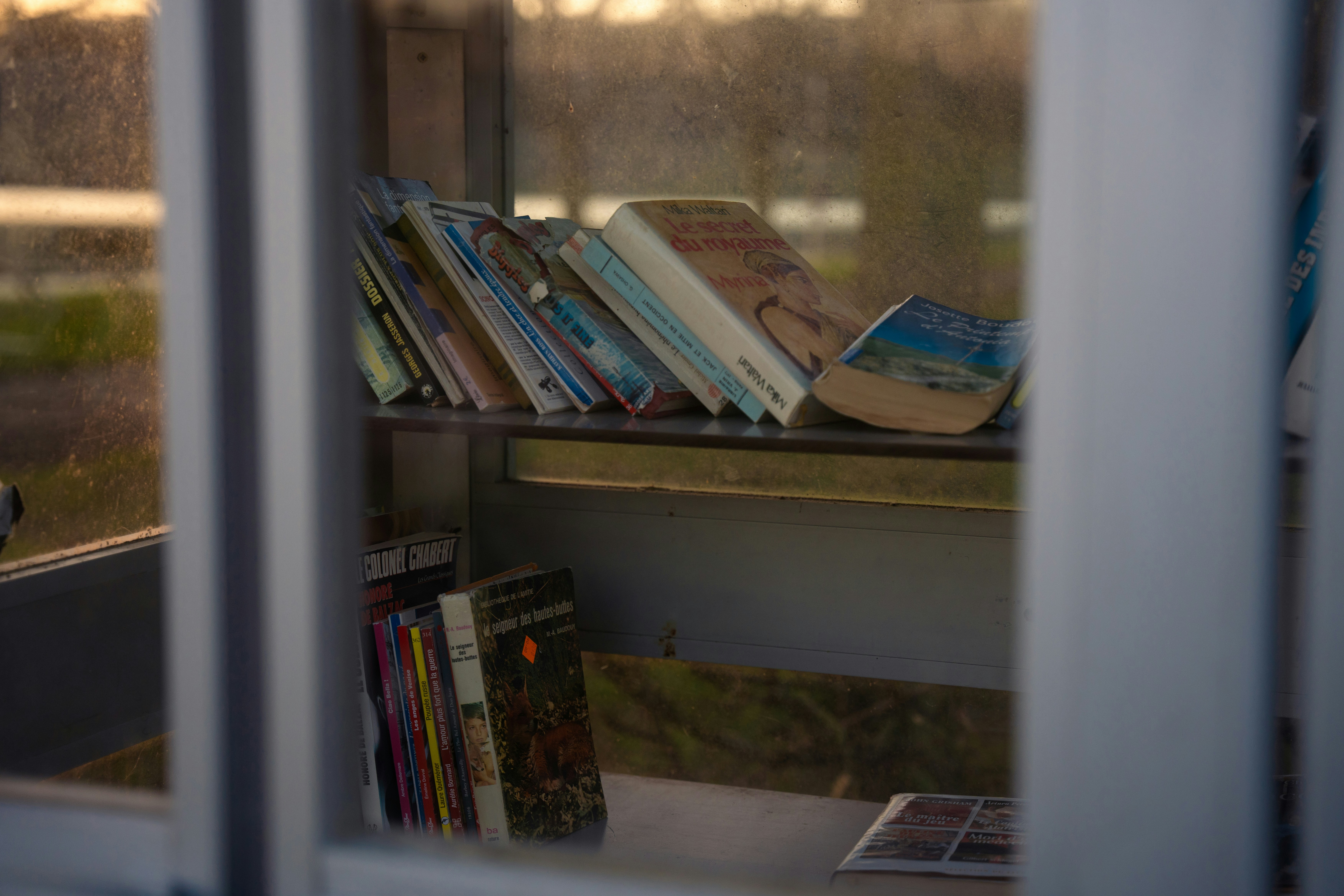 A window sill filled with books next to a window photo – Free Book ...