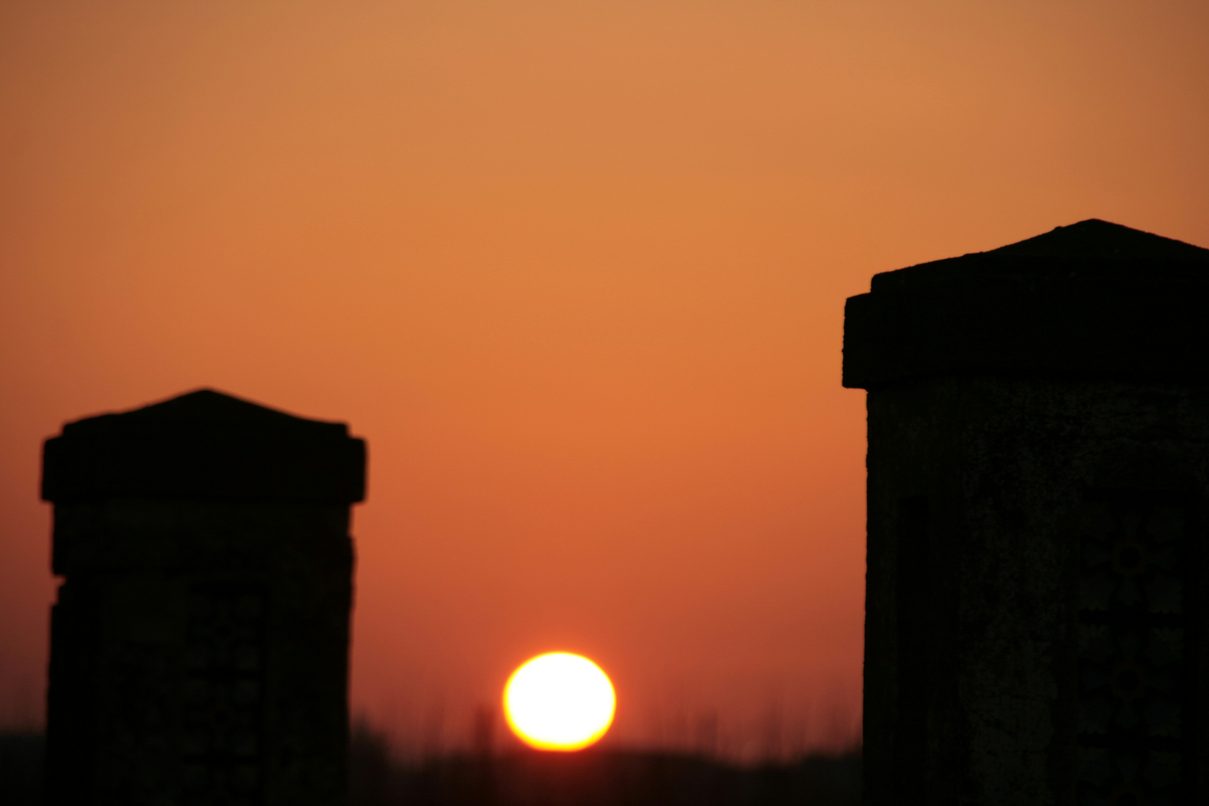 Sunset Between Chimney Silhouettes: A Quiet Horizon