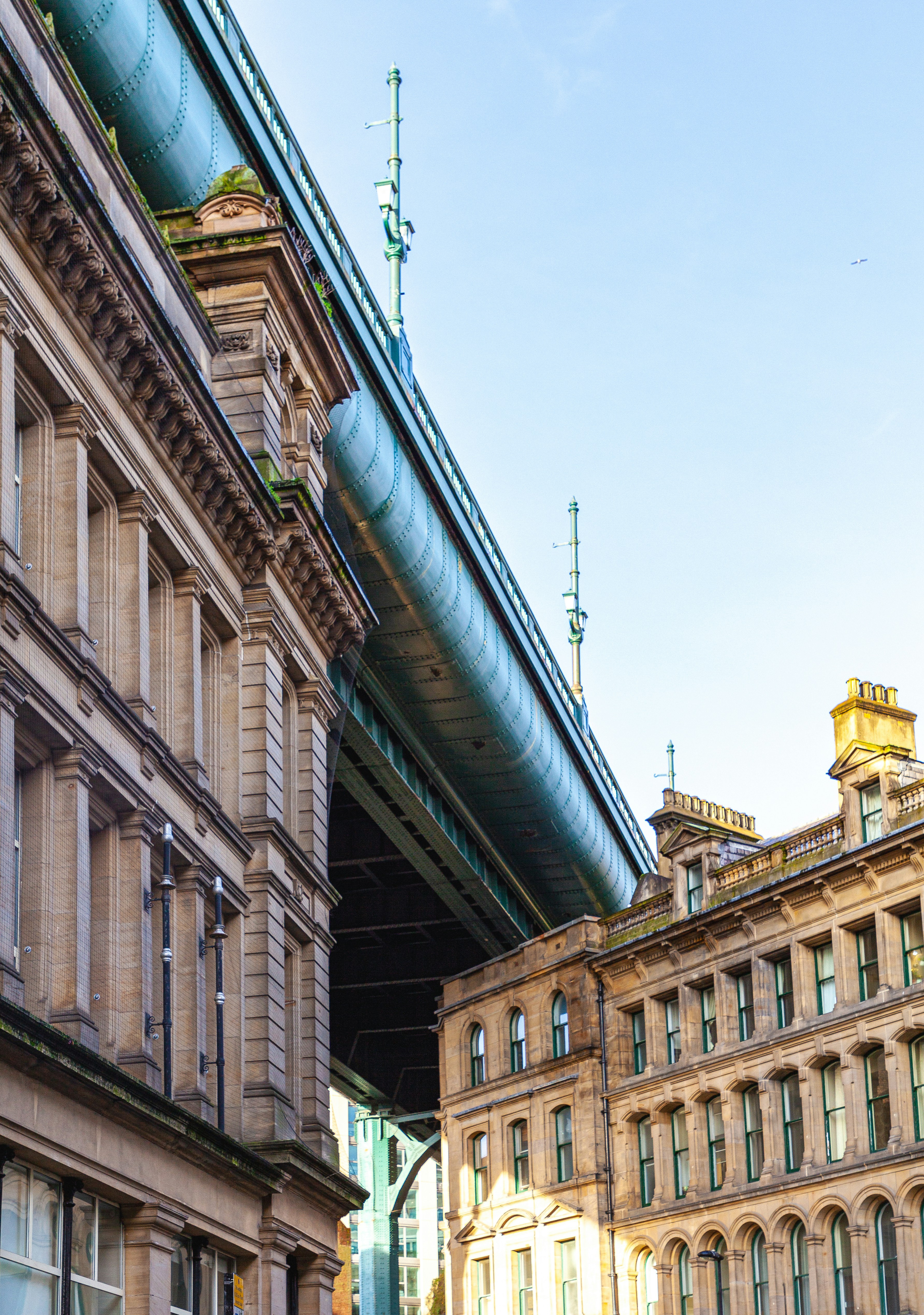Skybound Rails Over Stone: Morning Light Between City Facades